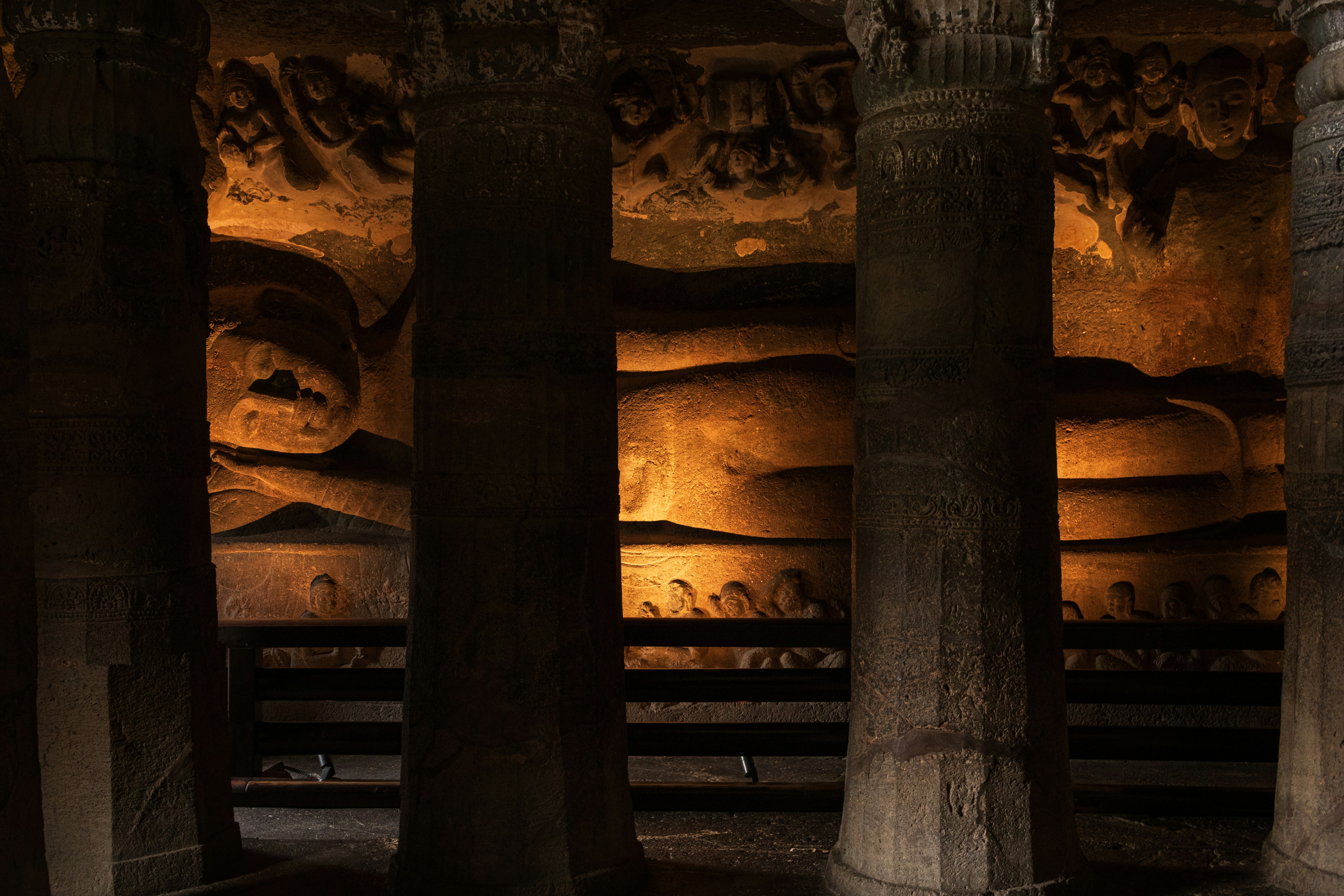 The famous Reclining Buddha sculpture in Cave 26 of the Ajanta Caves in Maharashtra, India, depicts Gautama Buddha lying on his right side during the Mahaparinirvana, representing his final passing from the mortal world into parinirvana. Measuring approximately 7 metres long, this monumental rock cut sculpture is carved into the cave wall and accompanied by a panel depicting grieving disciples and other figures, while celestial beings appear above. Dating to the Buddhist artistic tradition of ancient India, the sculpture is celebrated for its remarkable scale and expressive detail.