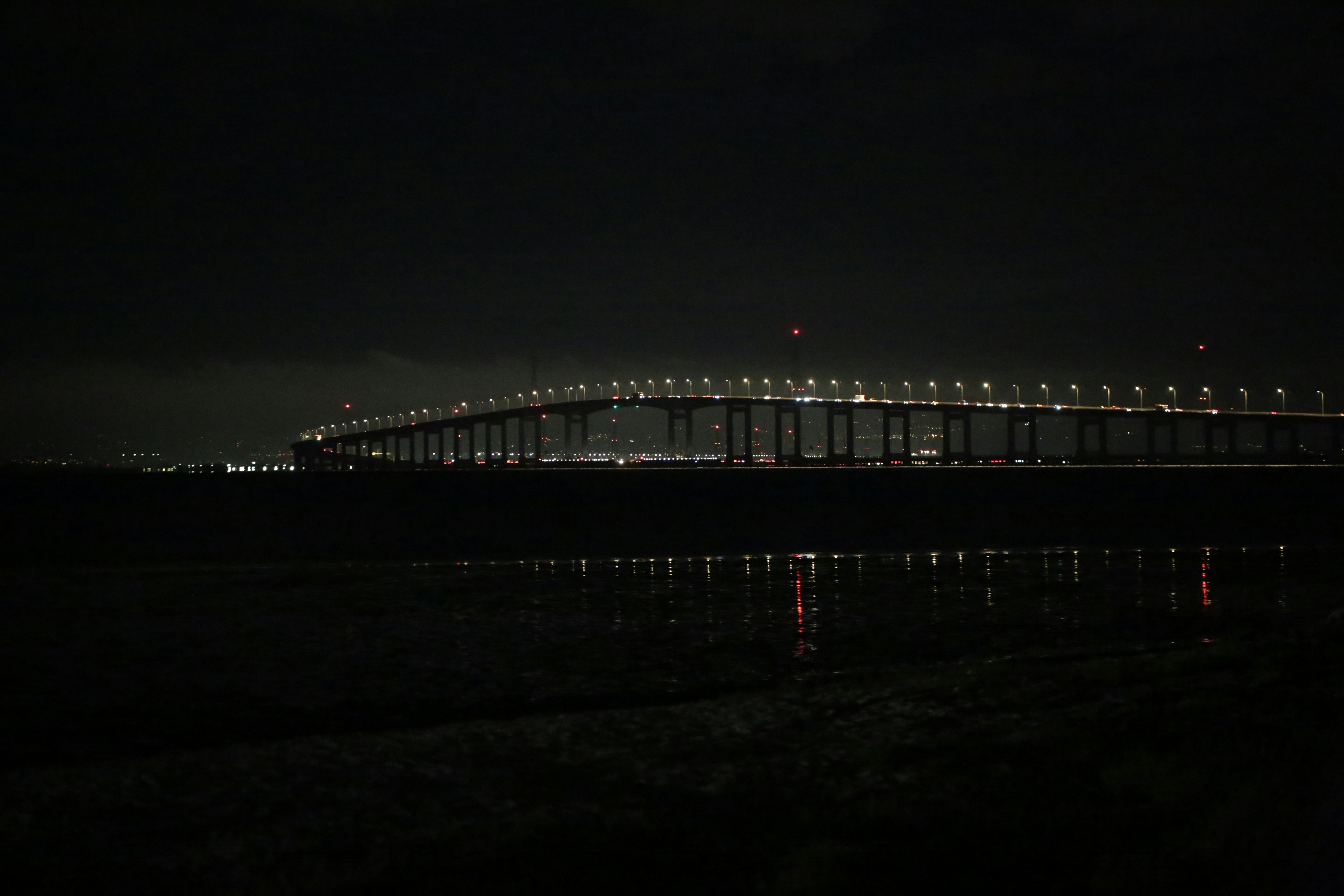 Midnight Arc: Lights Tracing a Quiet Waterfront Bridge