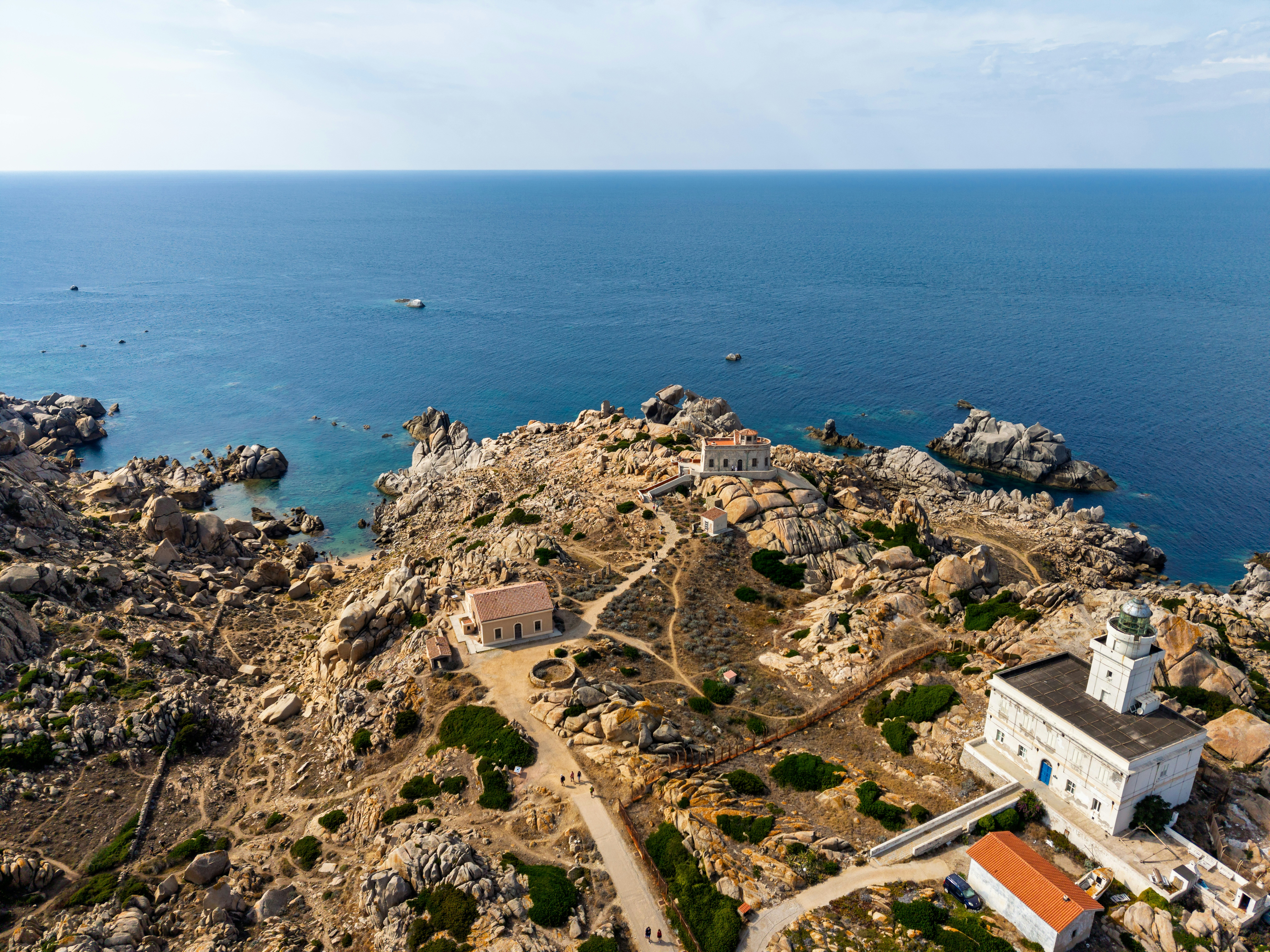 Coastal Settlement Nestled among Drifted Stones Under a Quiet Sea