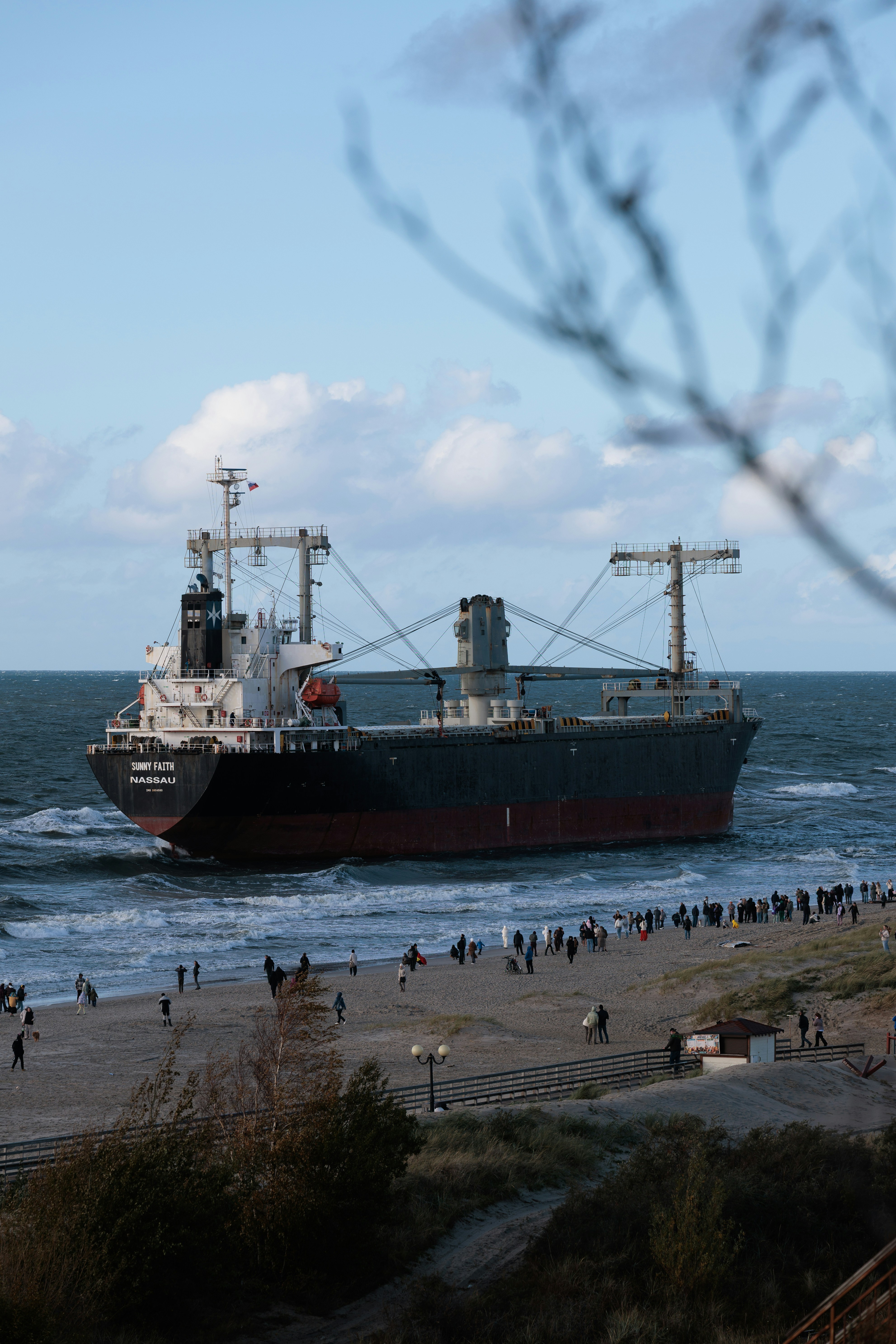 Ocean Freight: A Vessel Looms Over a Crowded Shoreline