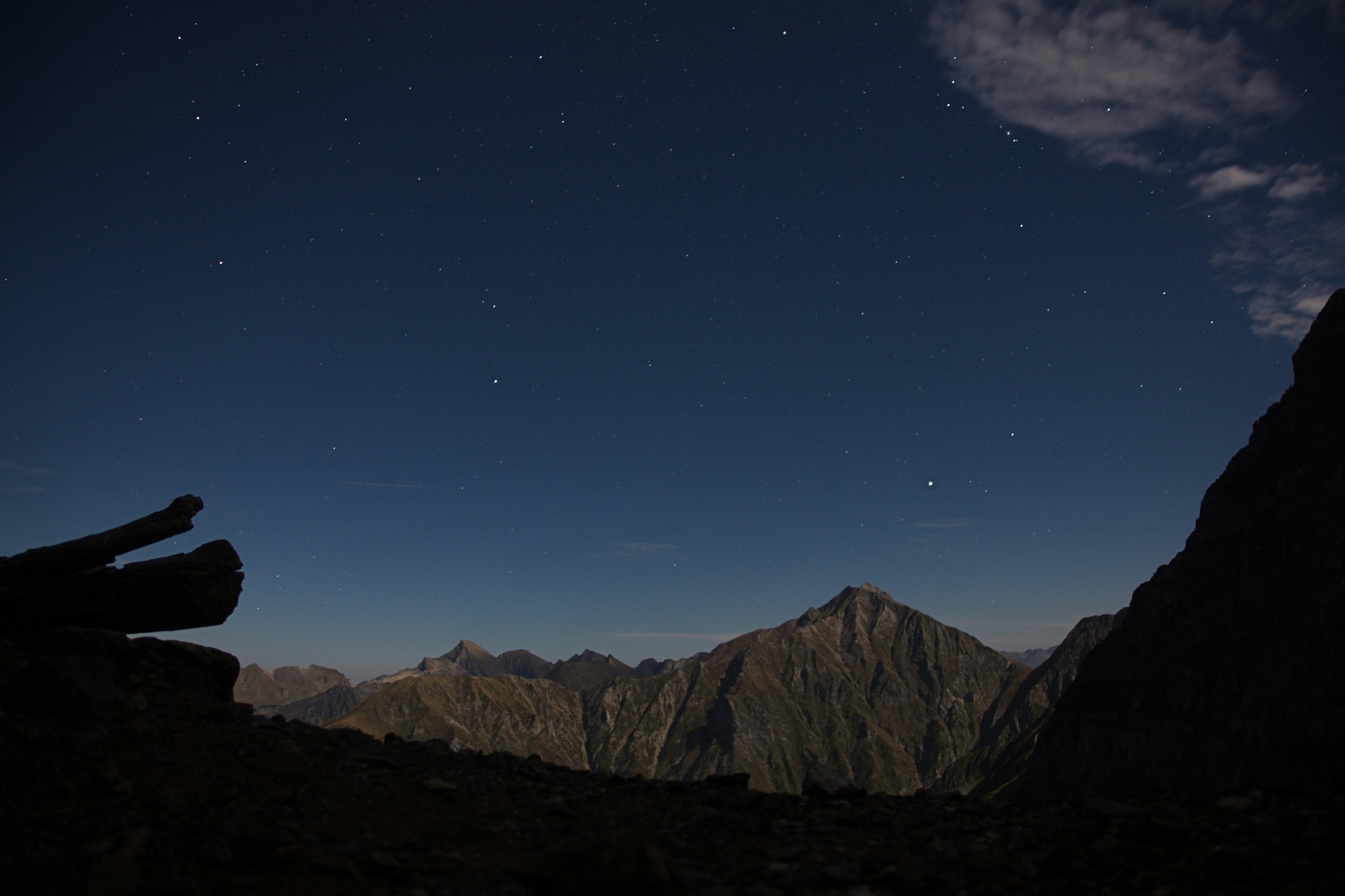 Moonlit Ridge: Stars Above a Deserted Alpine Vale