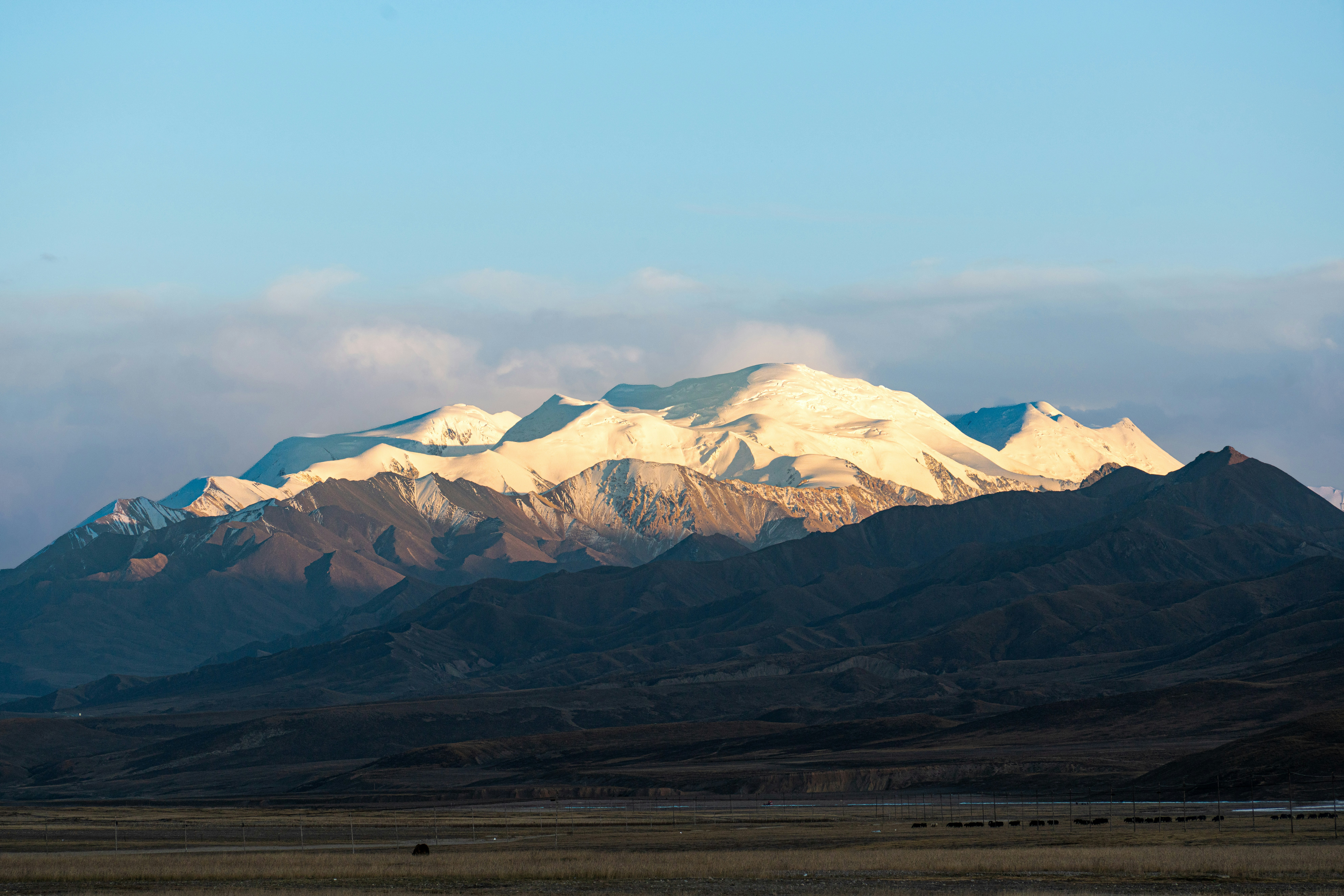 Snow-kissed Peaks at Dusk Over Quiet Farmland