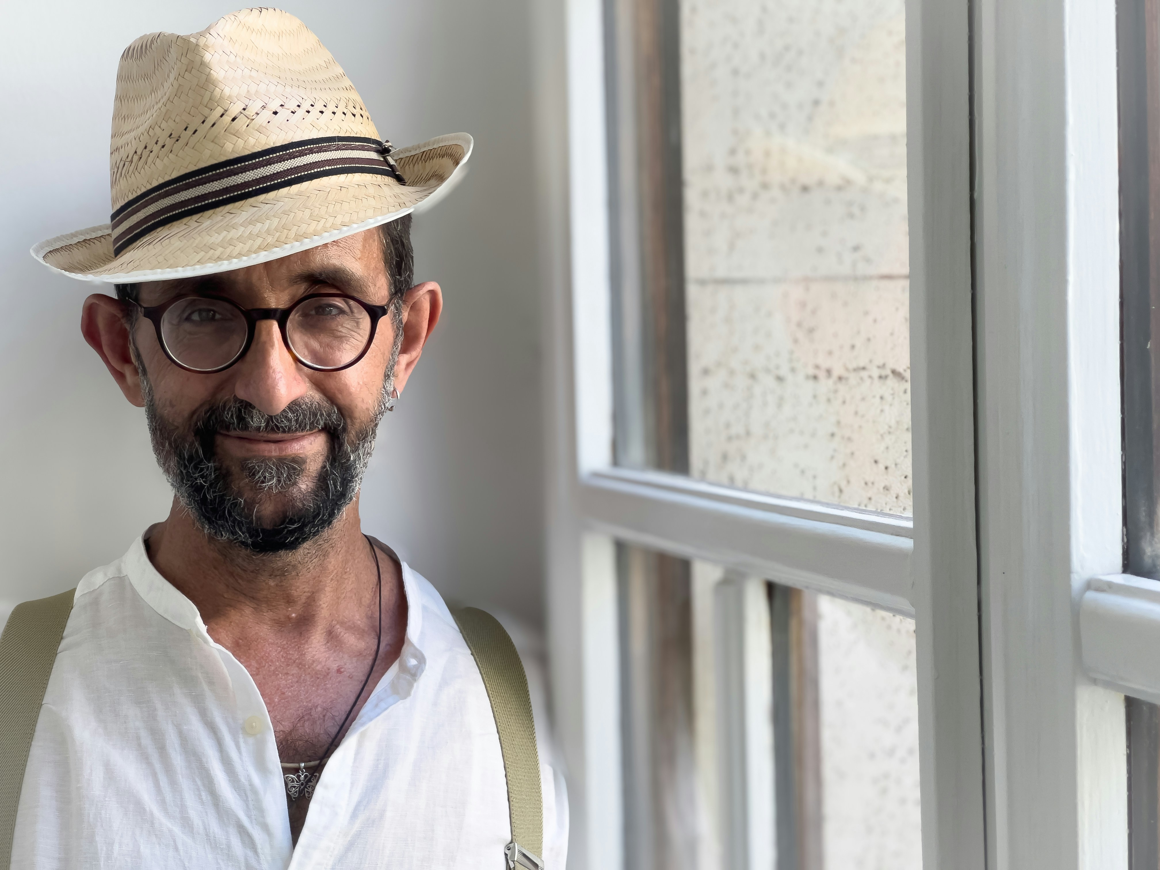 Gentleman in a Straw Hat: Quiet Confidence by the Window