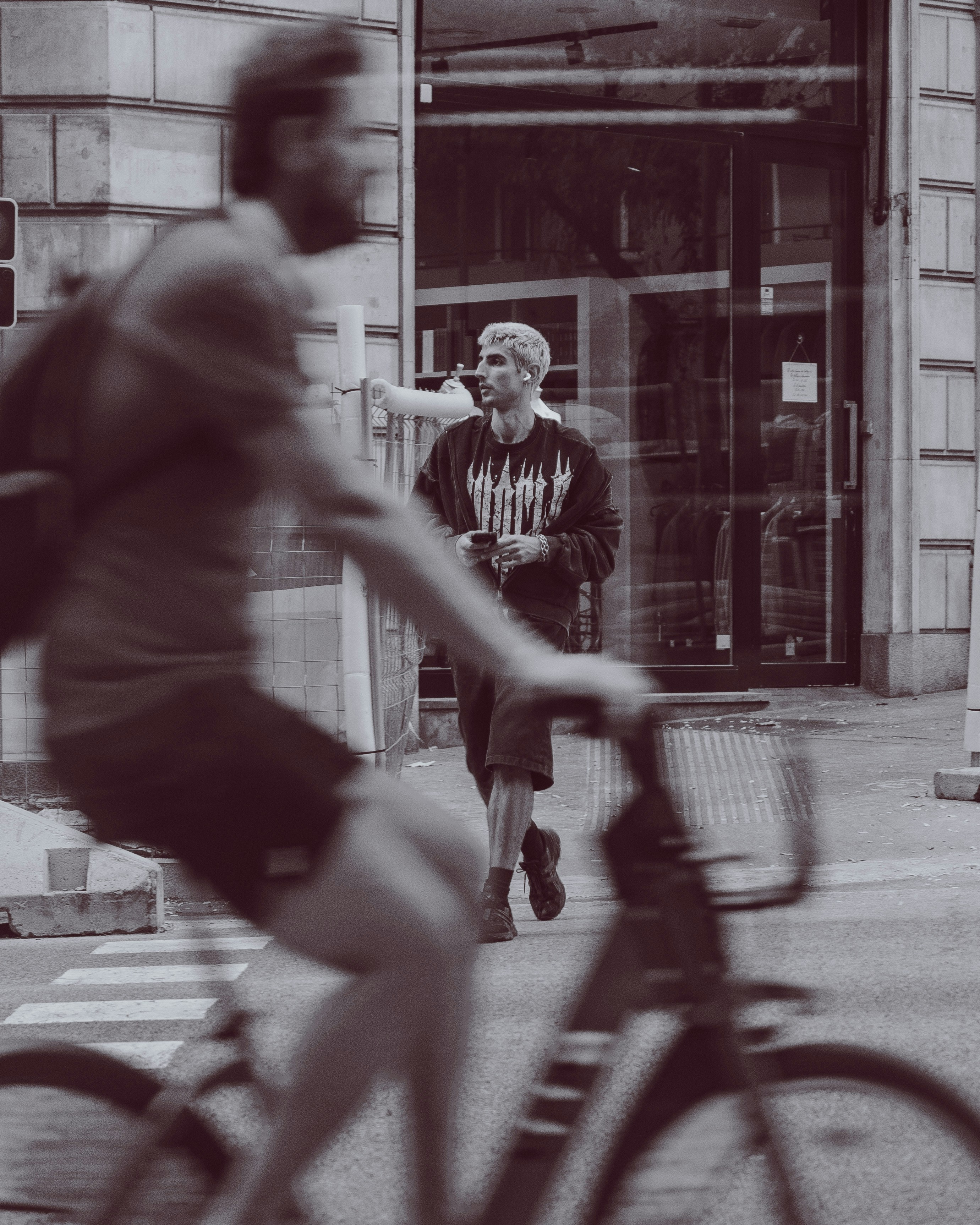 Street Interruption: A Bicyclist Passes as a Chord of Focus Rest on a Pedestrian