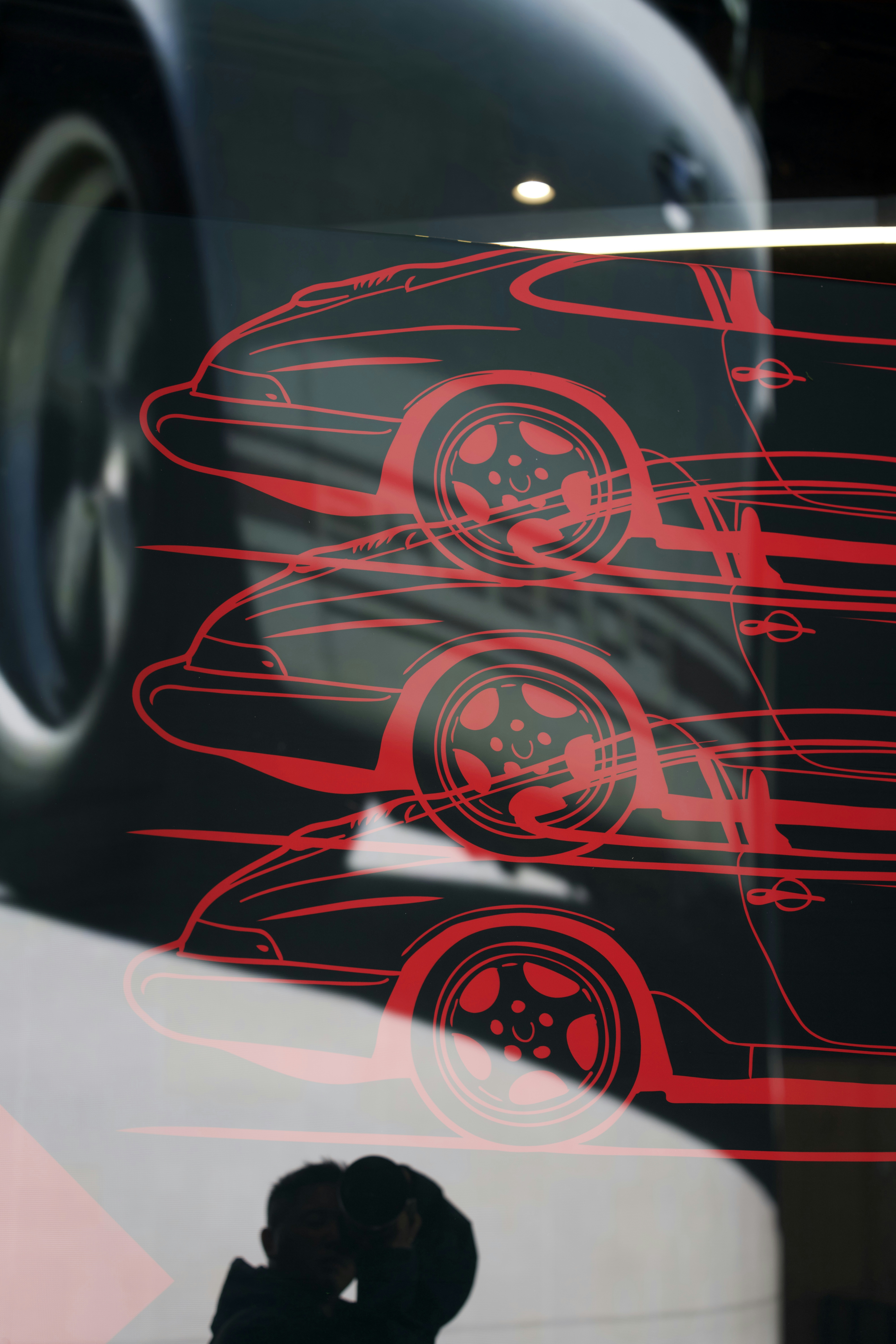 Red Outline of Speed: A Glimpse Through Car Art on Glass