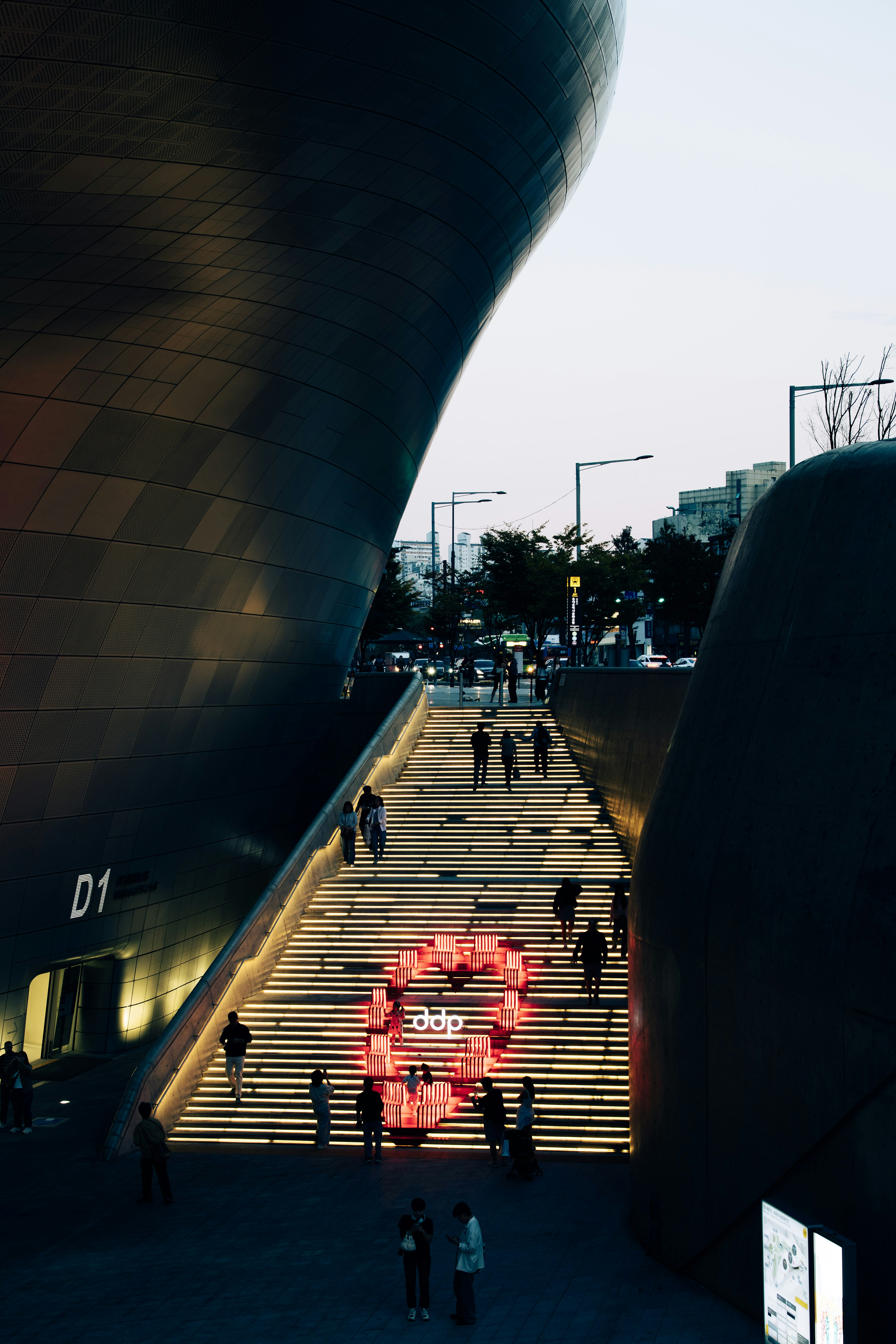 Neon Circle on the Steps: A Night Walk Through a Modern Atrium
