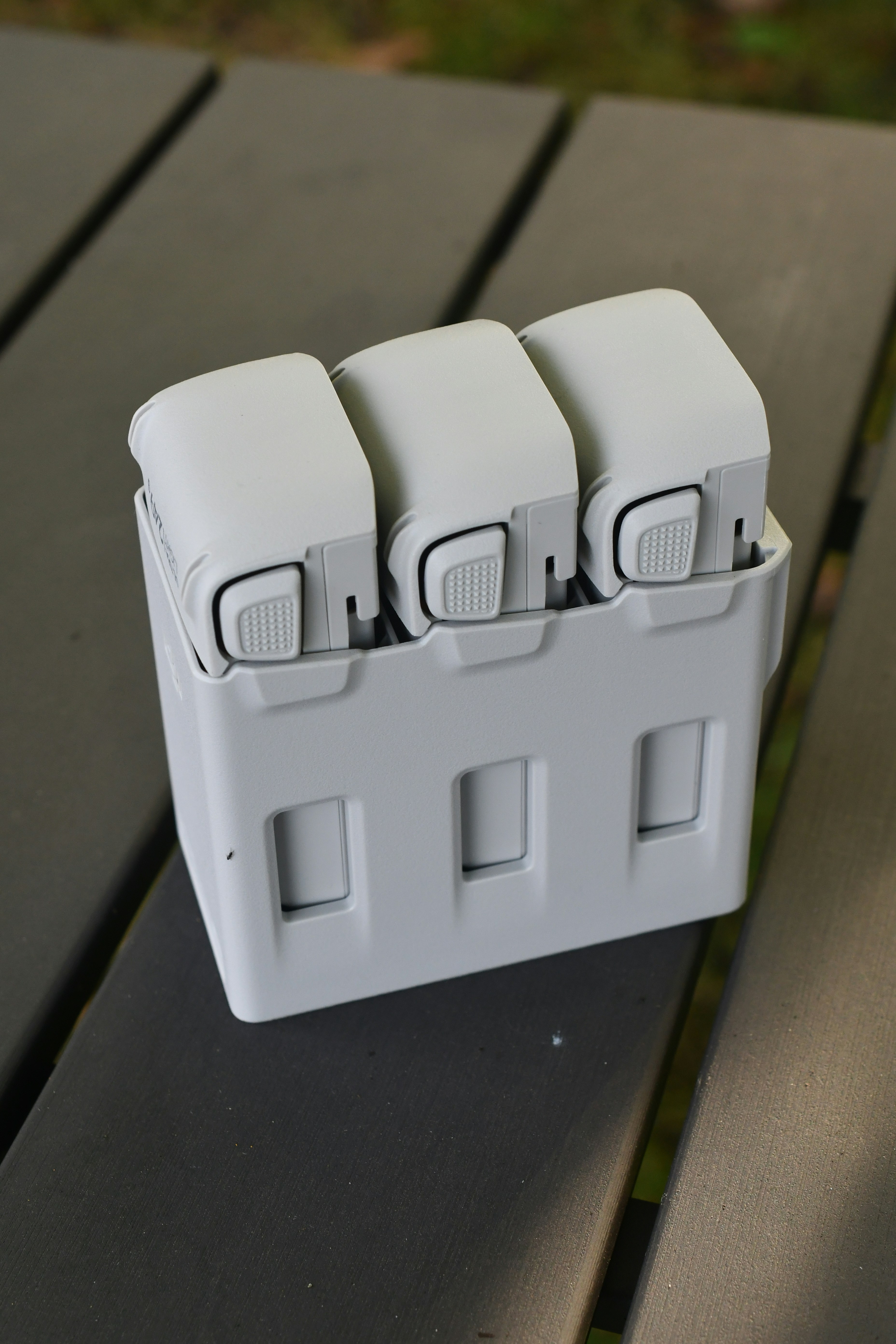 Triple-Clip Battery Pack on Weathered Bench