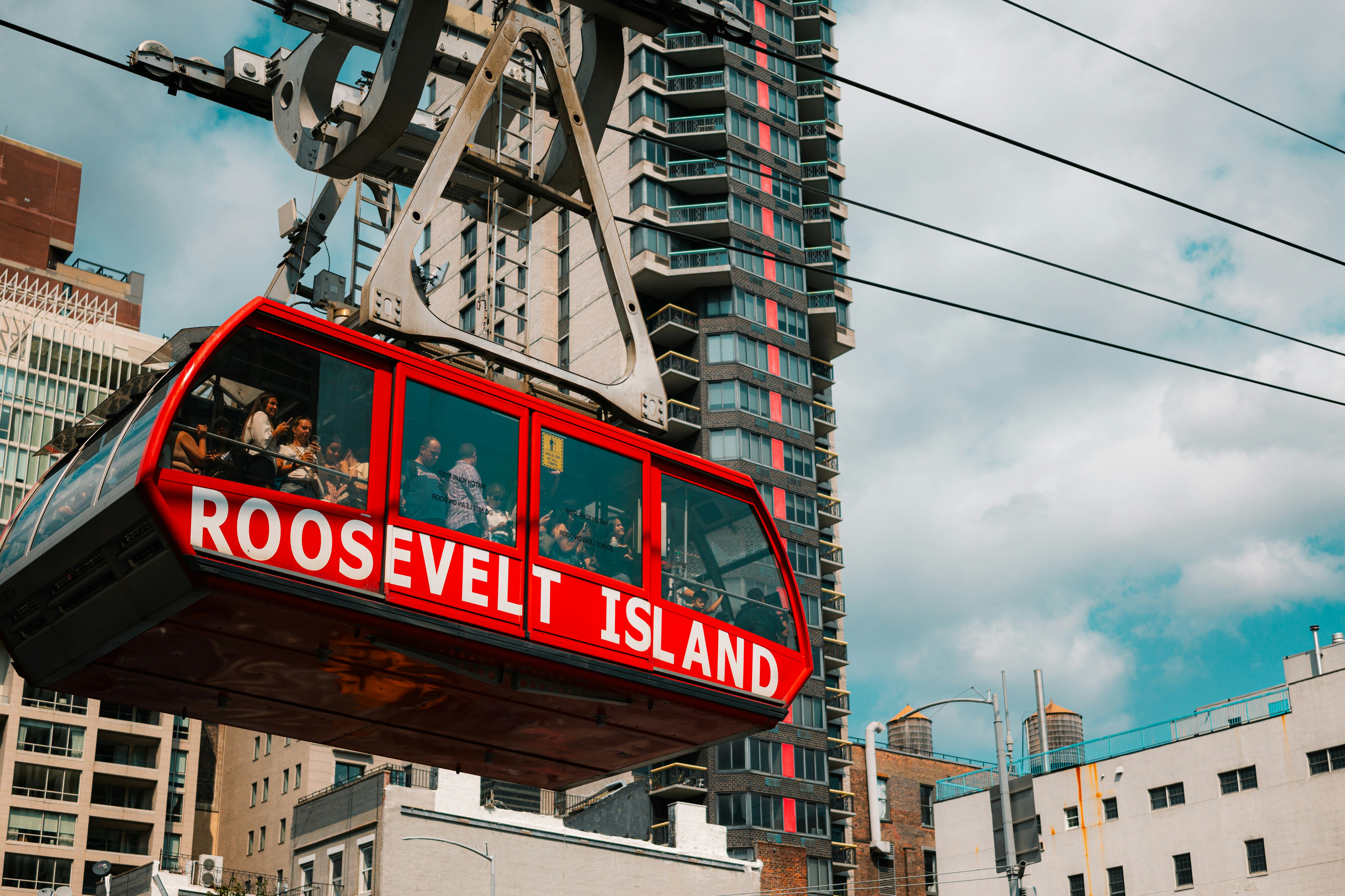 Roosevelt Island Skyride: A Red Cable Car Amid Urban Glass