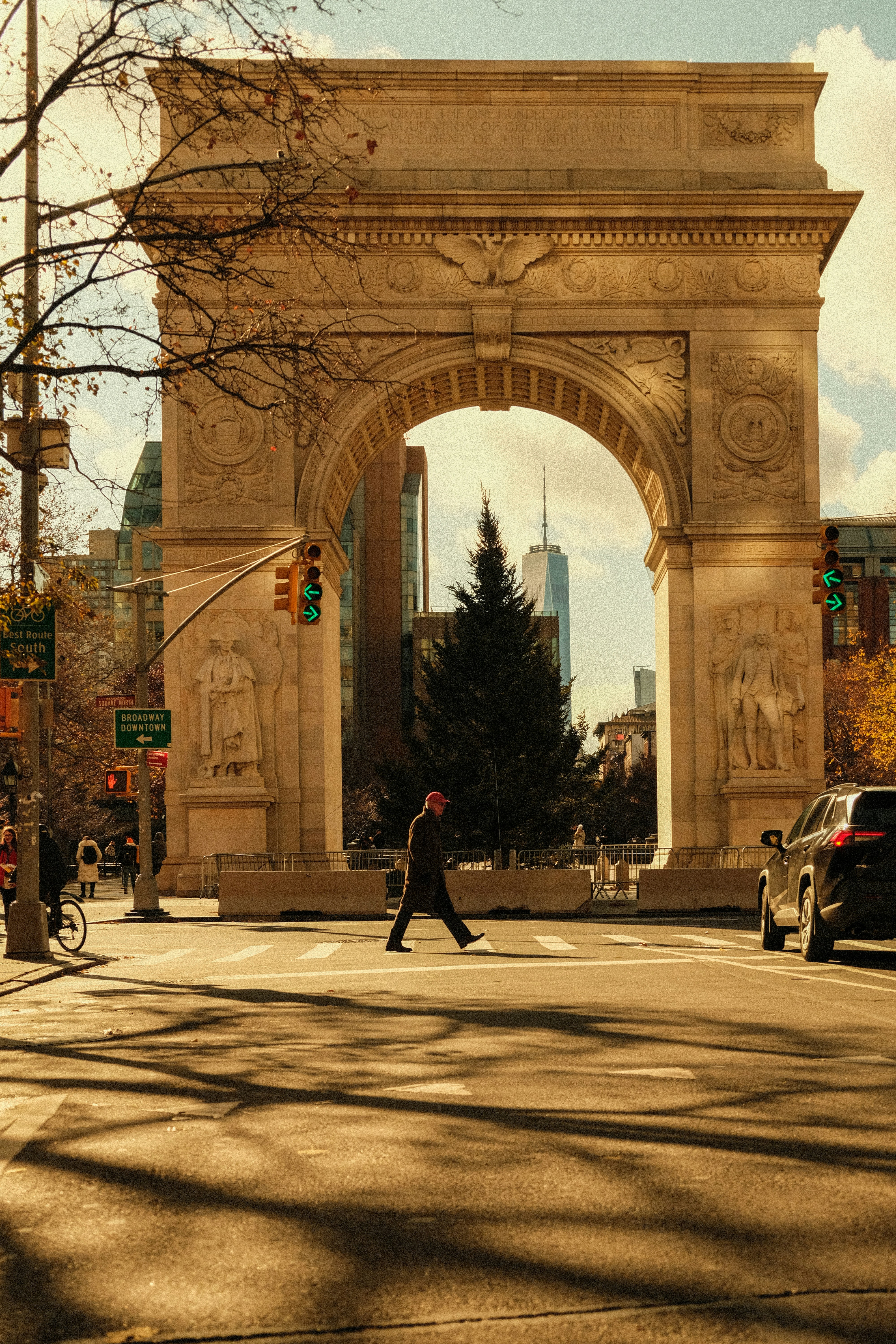 Archway Frame: A Pedestrian Traverses the Grand Arc in Autumn Light
