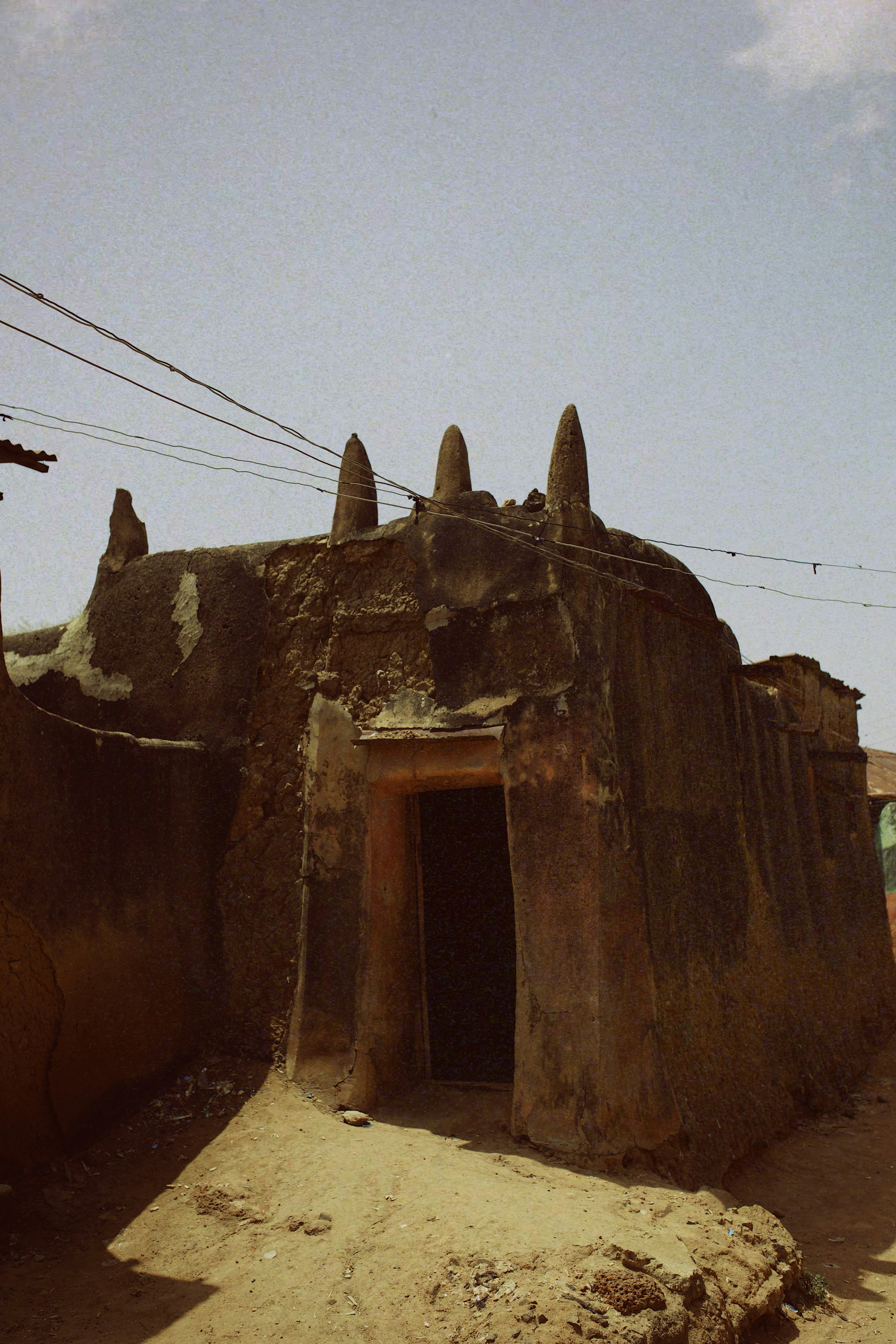 Deserted adobe fortress under a taut wire and horned silhouettes
