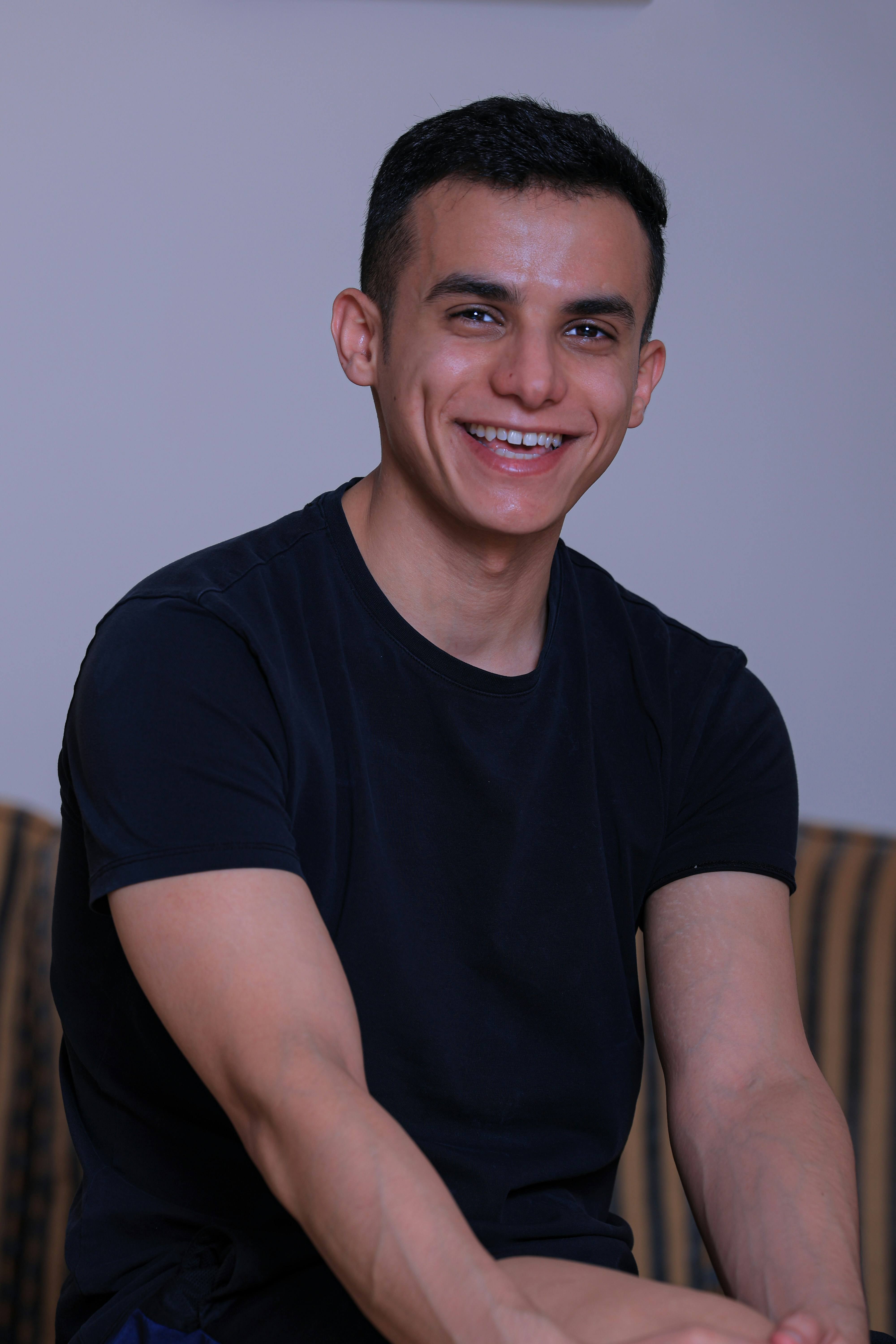 Smiling in Focus: Casual Portrait of a Confident Young Man