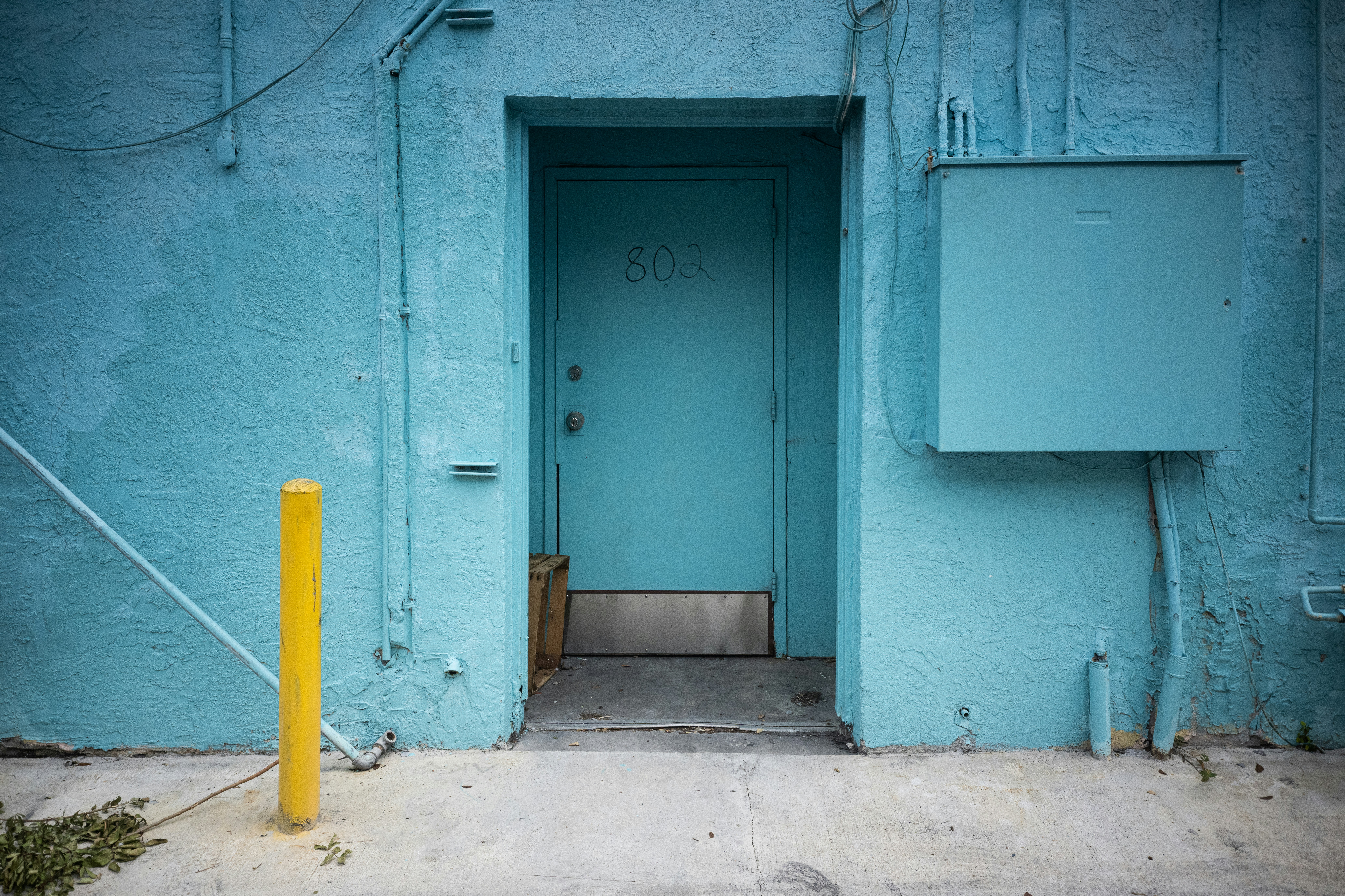 Electric Turquoise Threshold: A Quiet Urban Portal