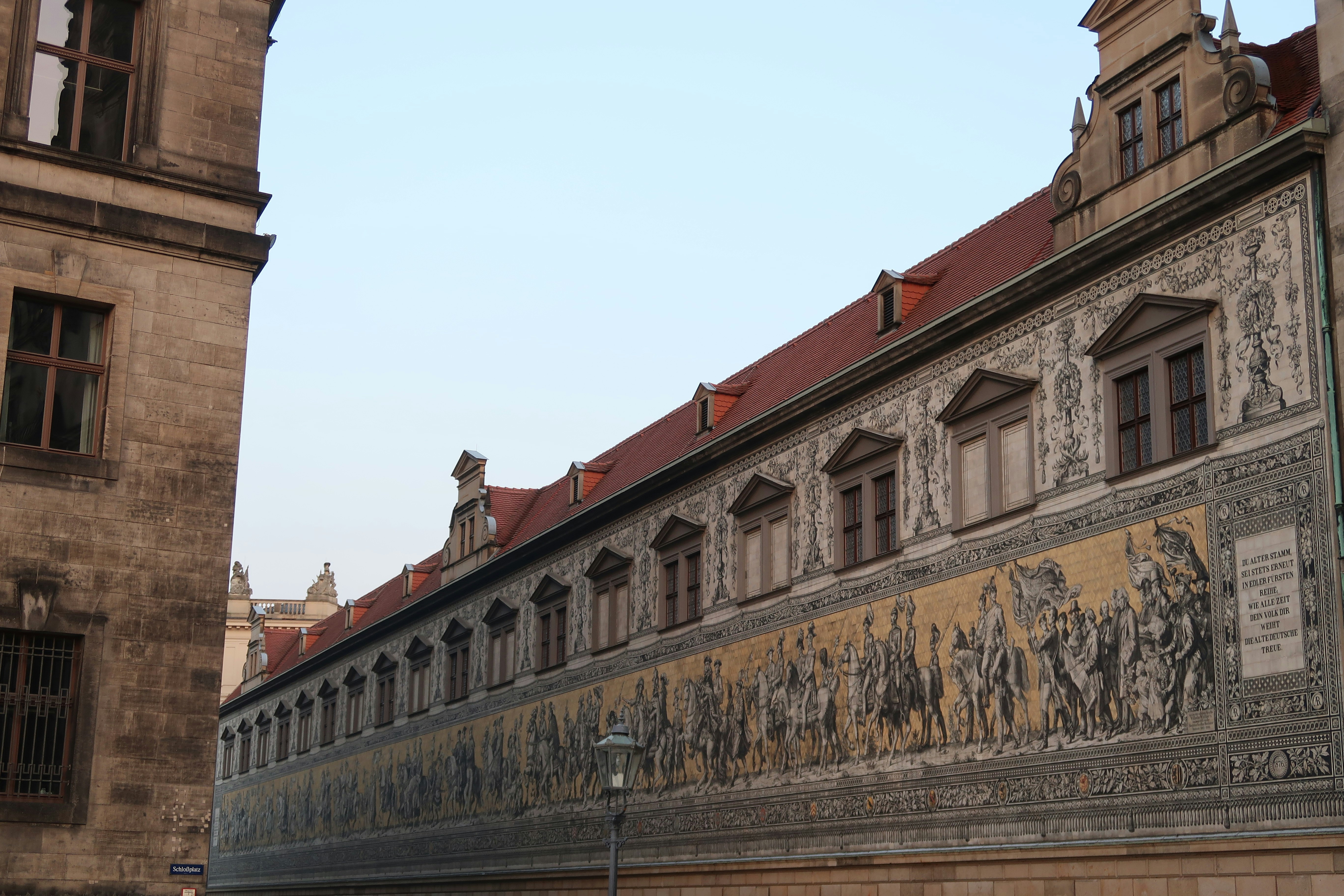 Muraled Monarchy: A Renaissance Frieze Against Astone-Walled Facade