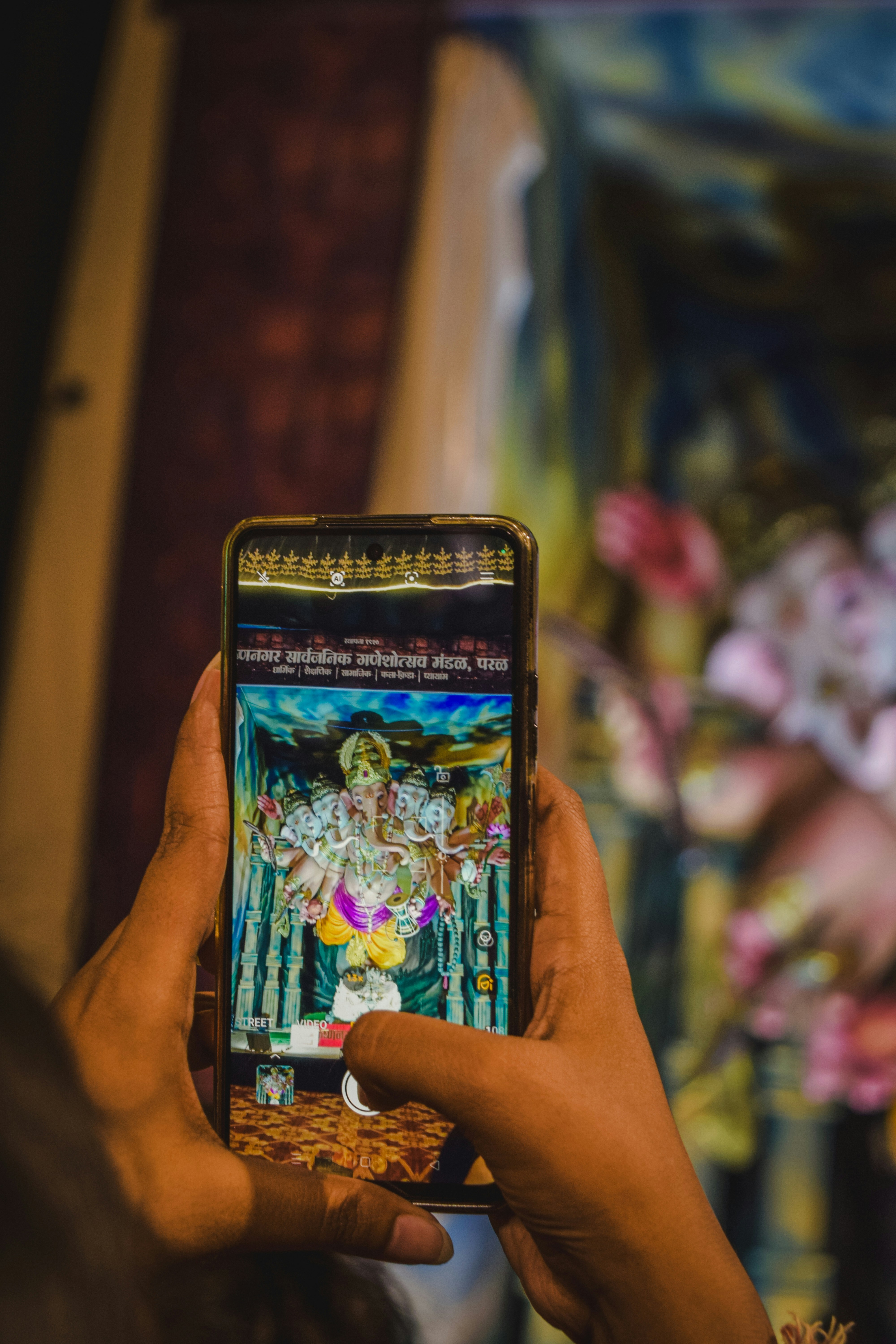 Phone Screen Portrait: Devotional Idol Framed by Handheld Capture