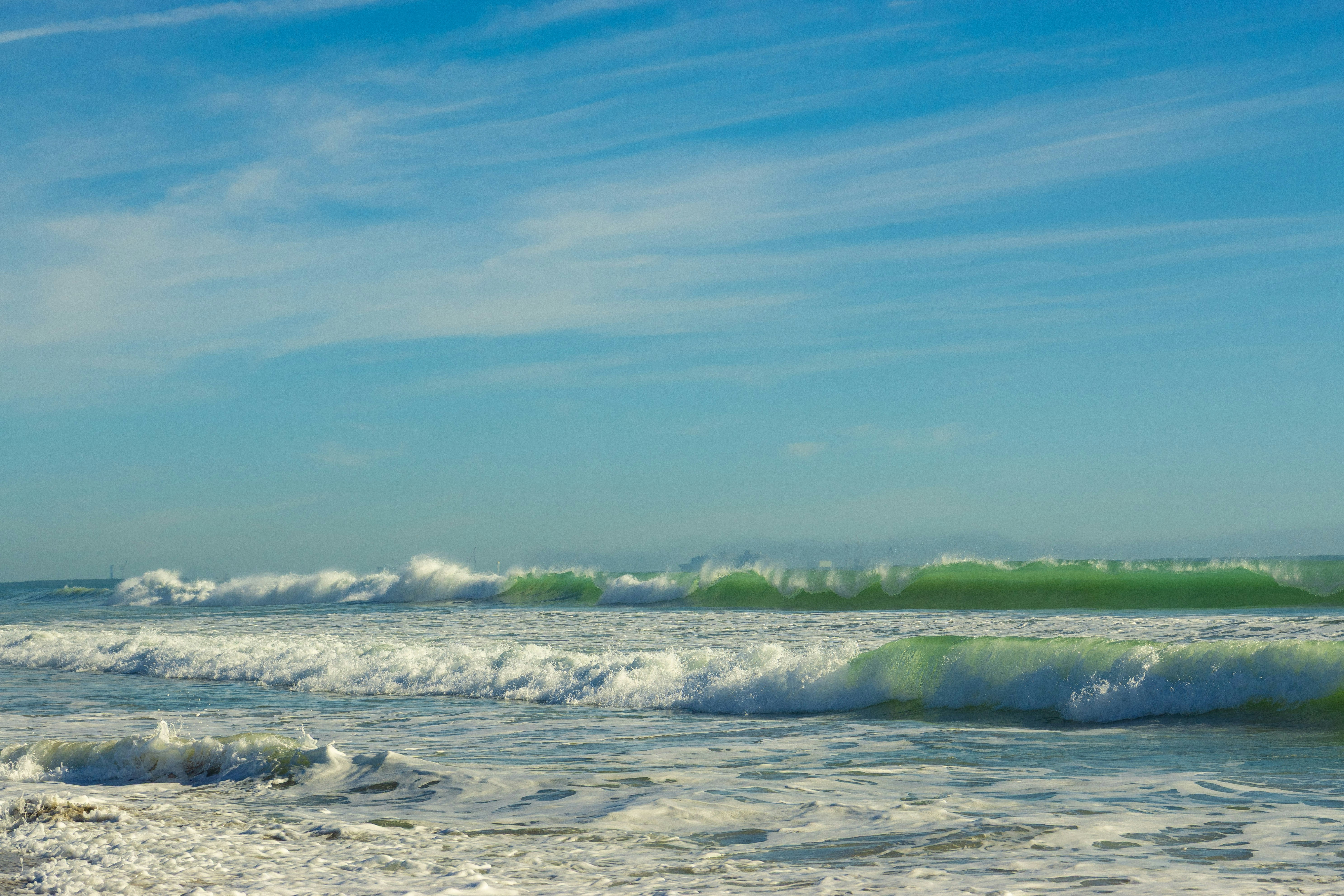 Green Crest Breakers Over Quiet Blue Continental