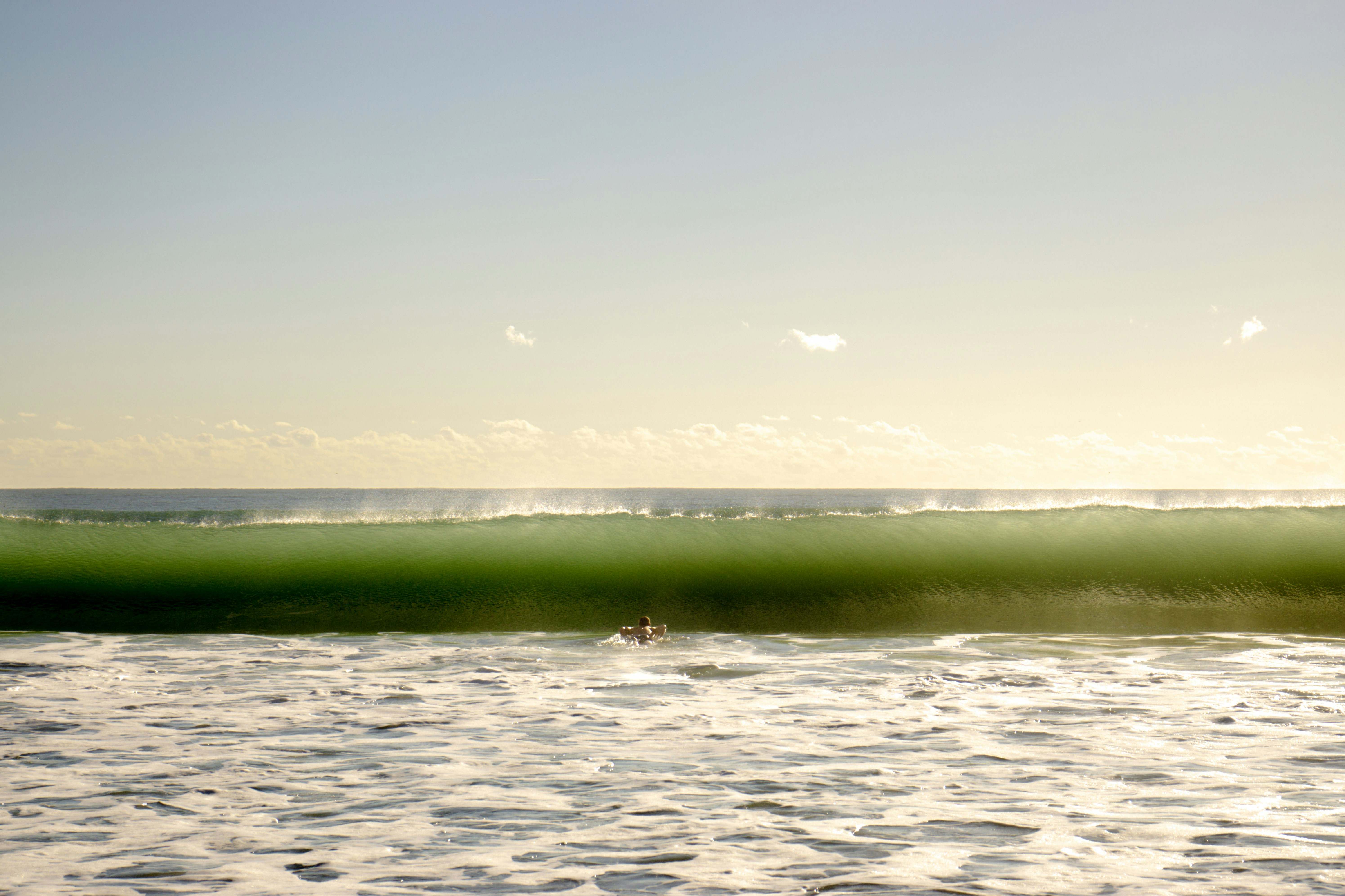 Green Crest of the Break: A Quiet Surf Moment at Dusk