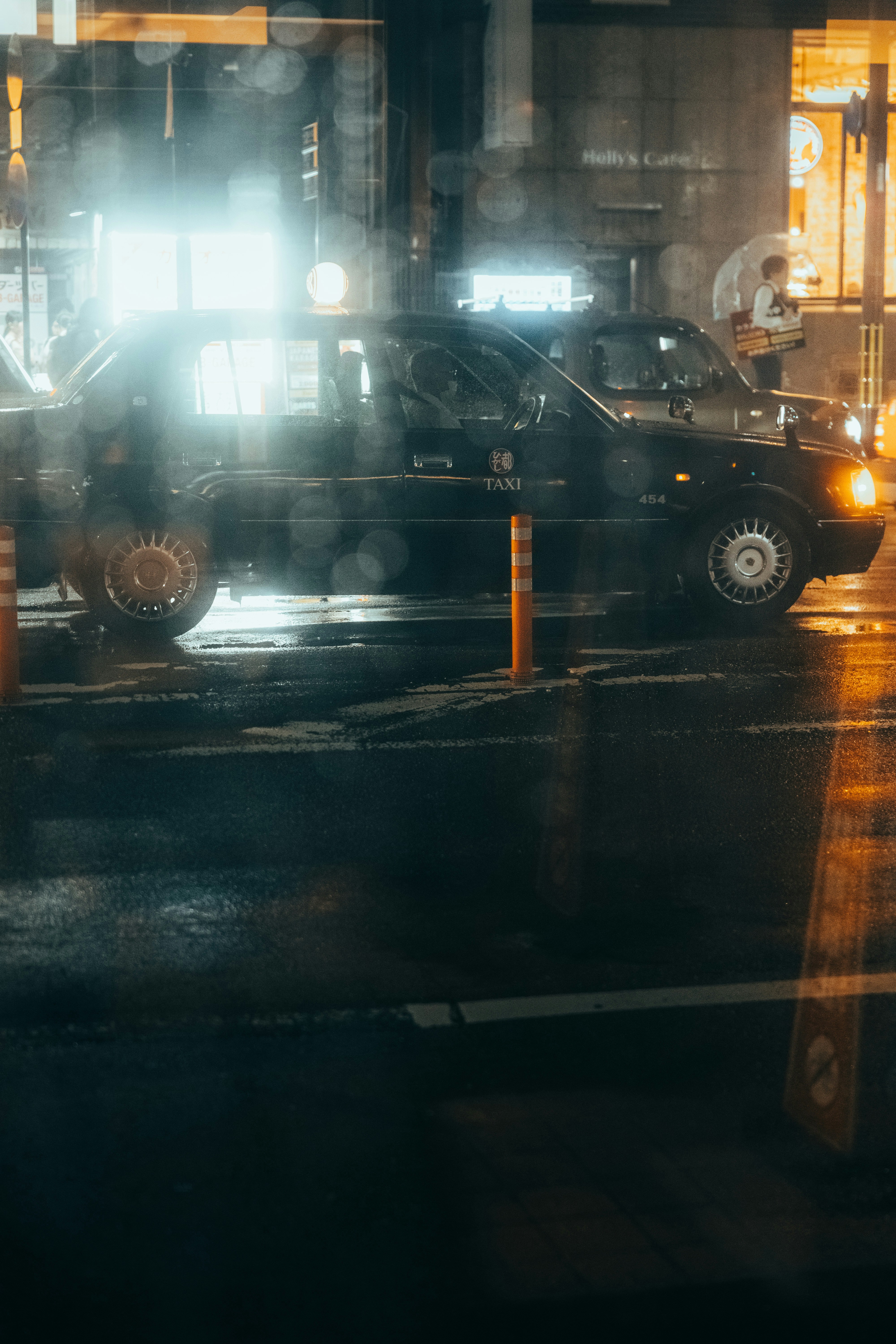 Night Taxi on Rain-Slicked Street: Neon Reflections through a Window