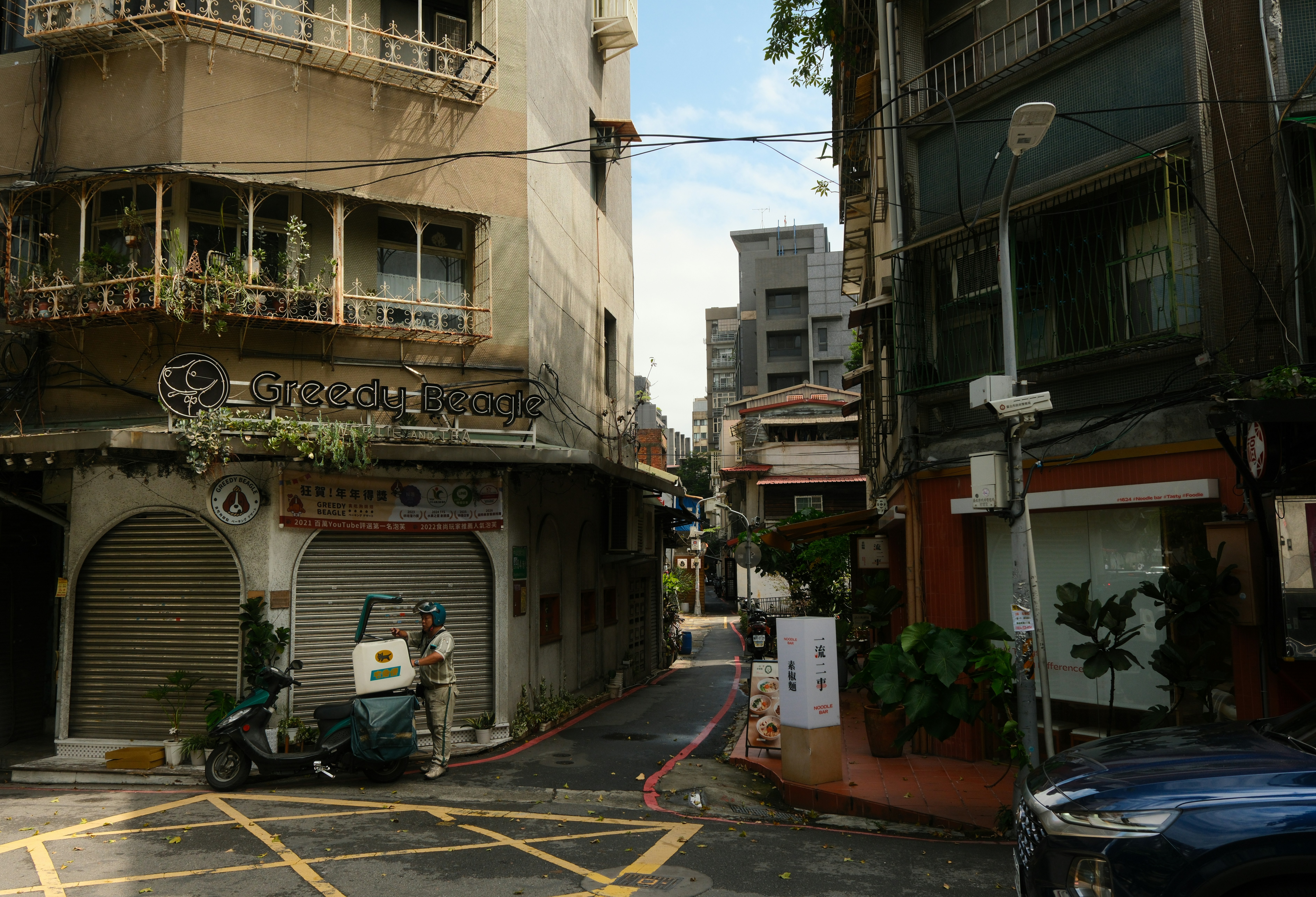 Urban Sunrise: A Quiet Alleyway Between Shuttered Shops