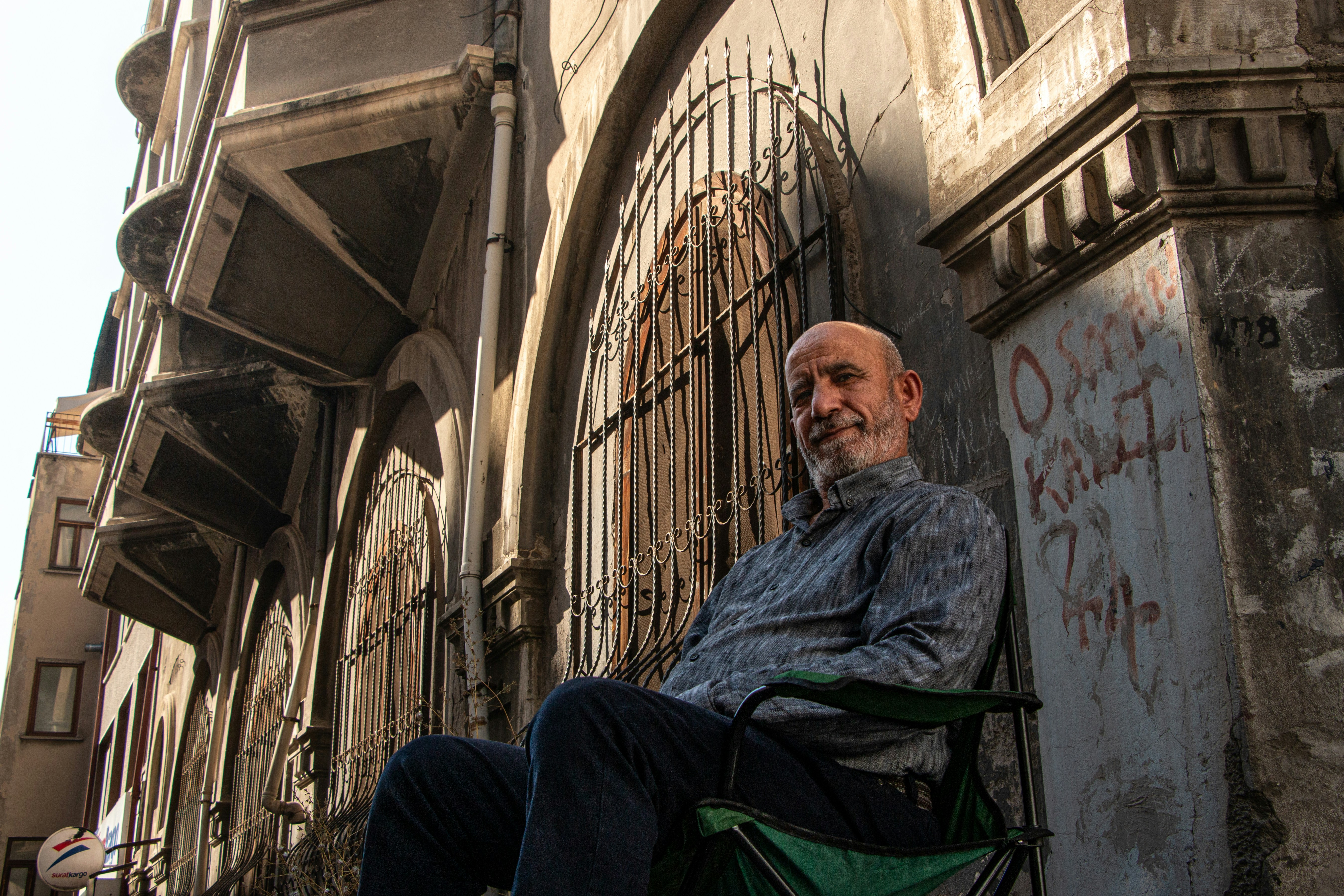 Bystander on the Steps: Quiet Confidence Amid Arcaded Decay