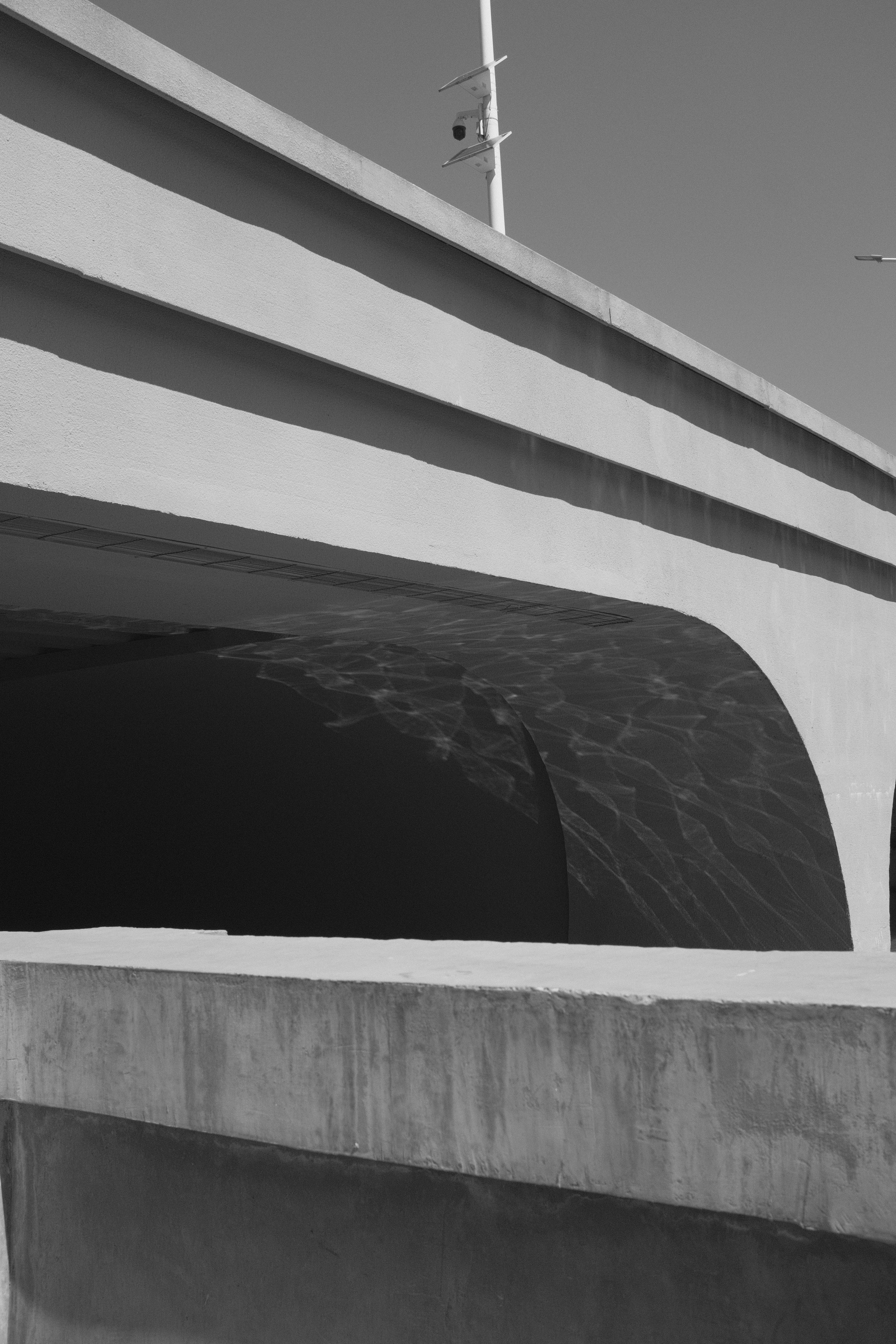 Concrete Arcways: Shadows and Light Under a Pier