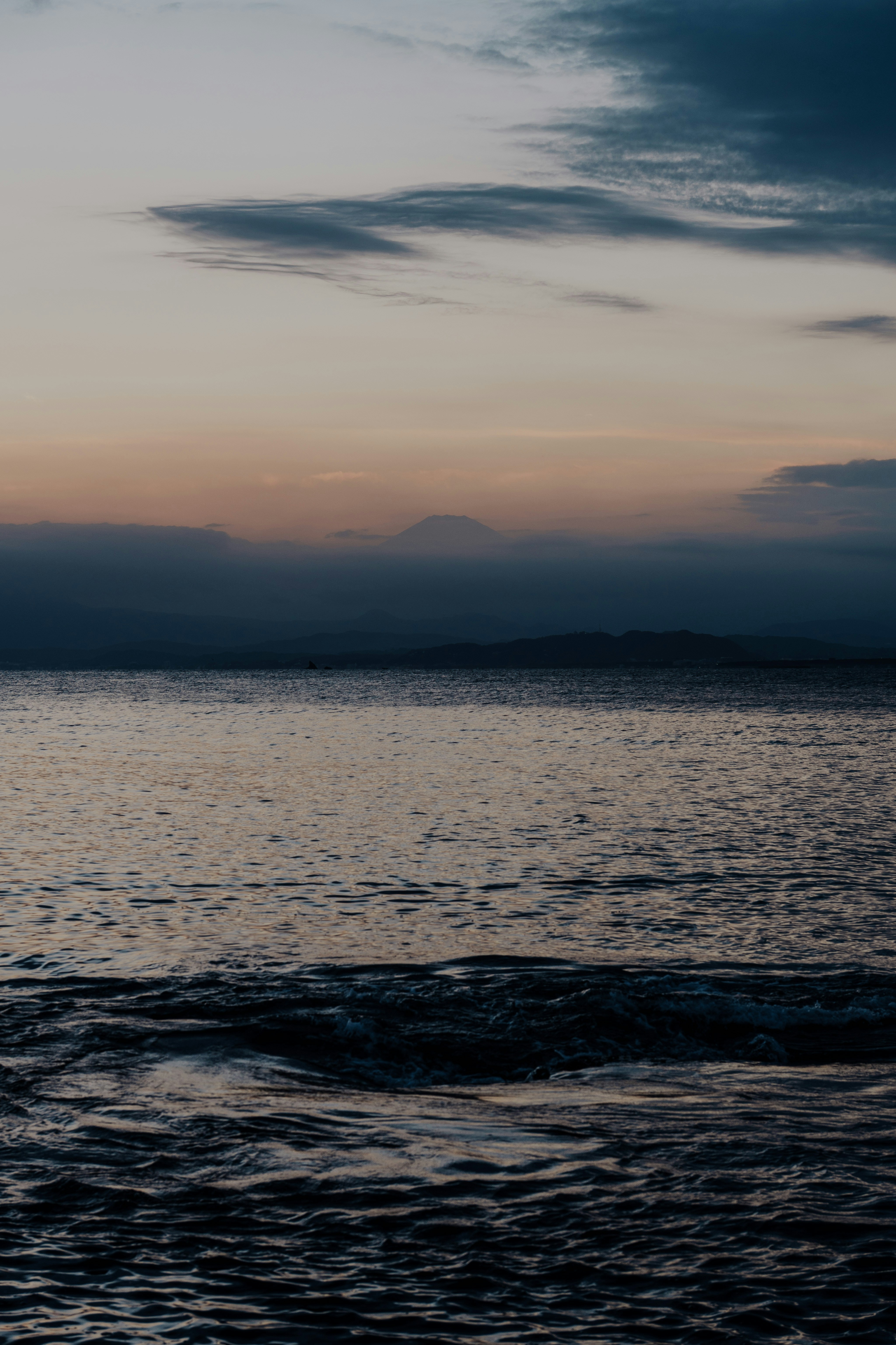 Dusk Over Quiet Seas: Silhouetted Horizon Beneath a Velvet Sky
