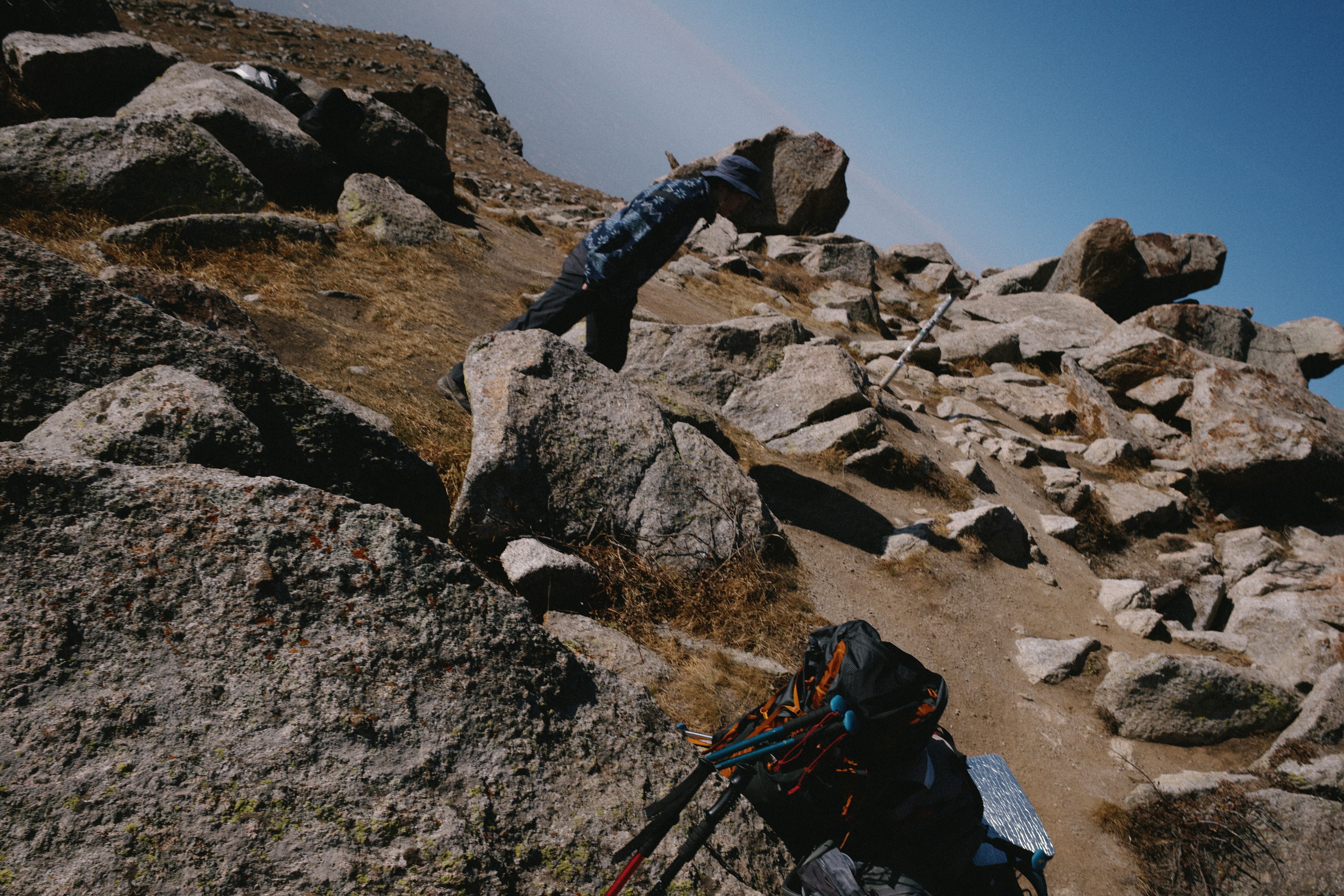 Climber's Ascent Across Jagged Dawn