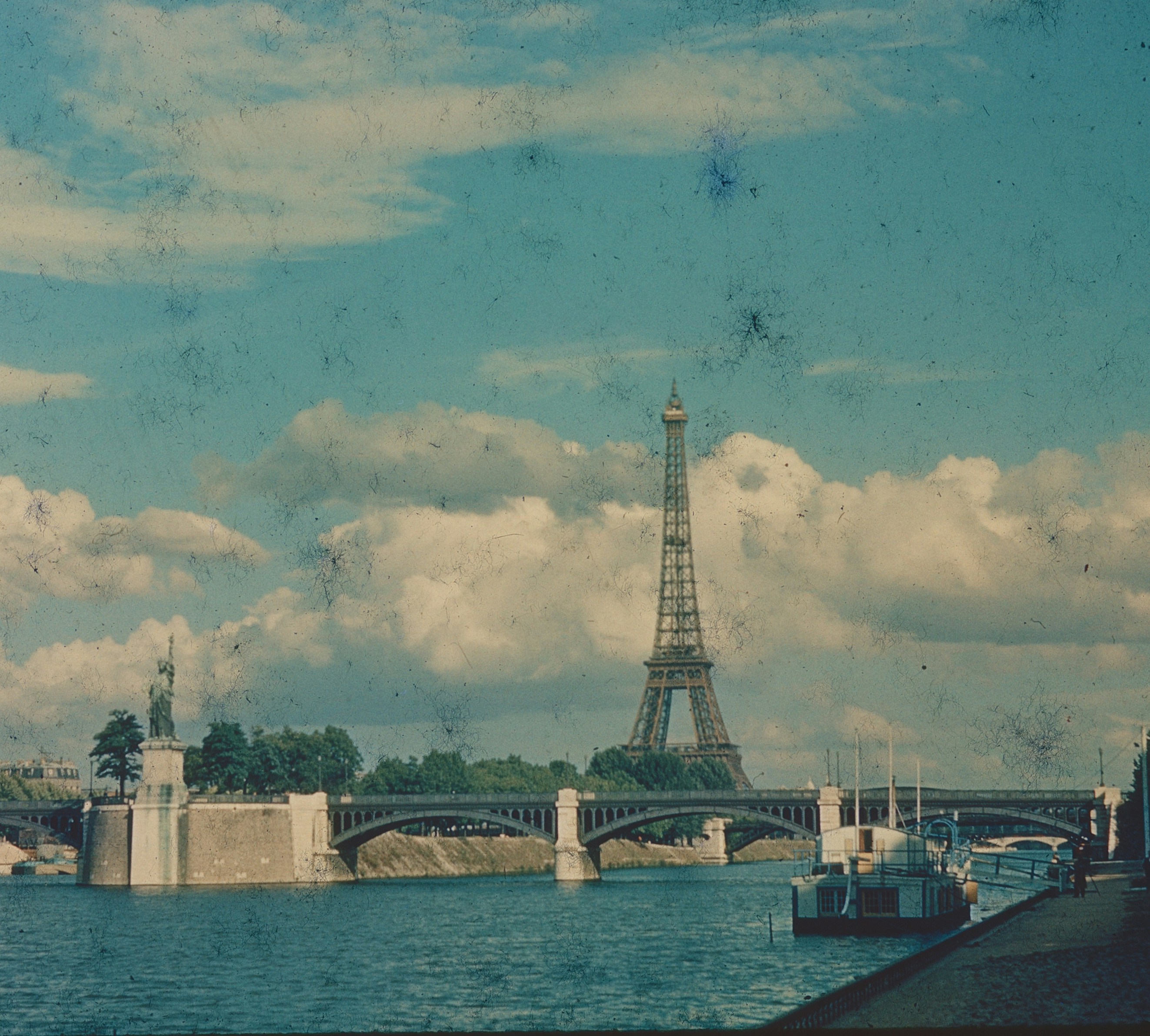 Parisian River Daydream: The Eiffel Tower Through Weathered Glass