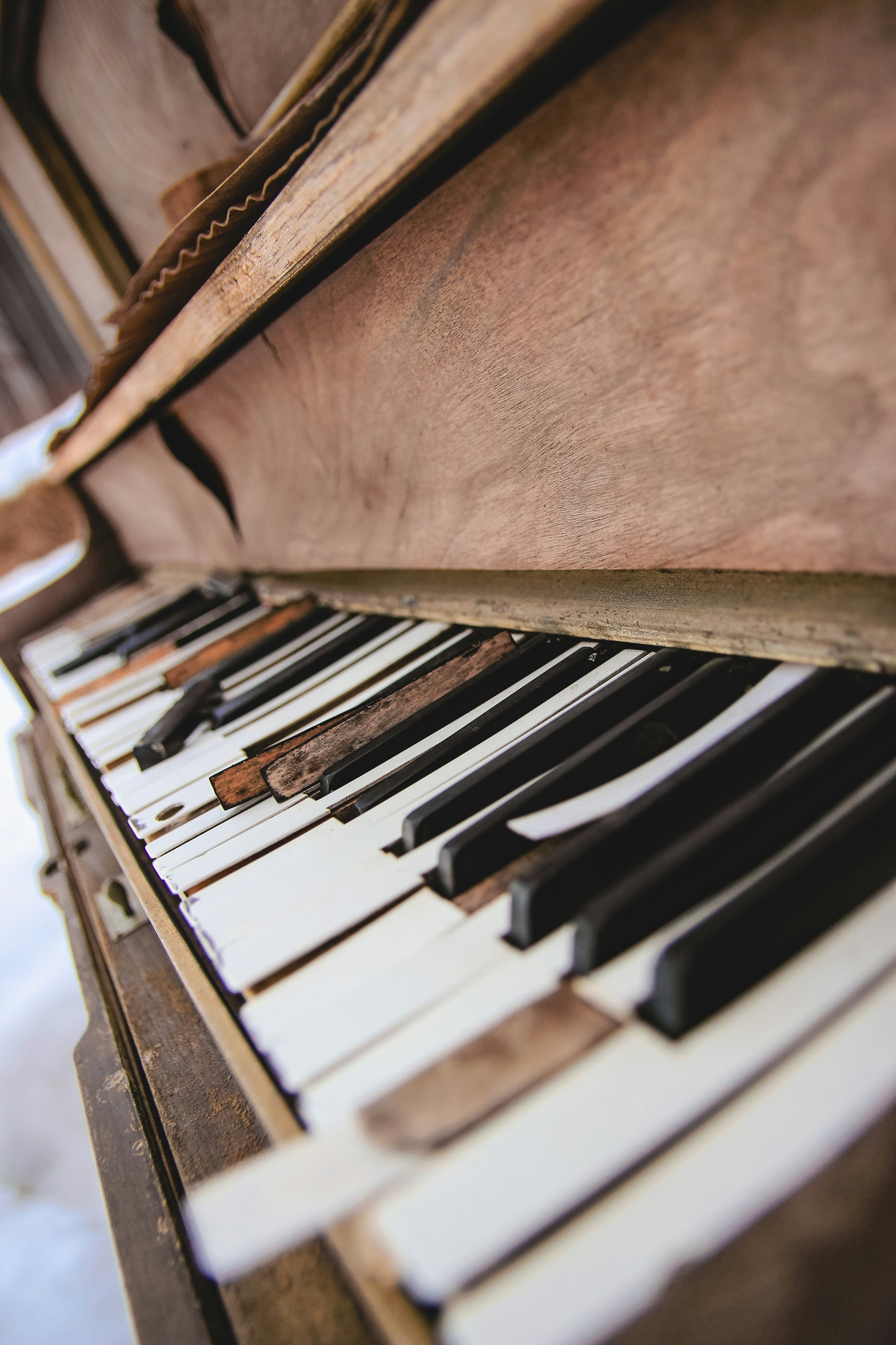 Weathered Ivory: Close‑up of Aged Piano Keys Amid Wooden Slats