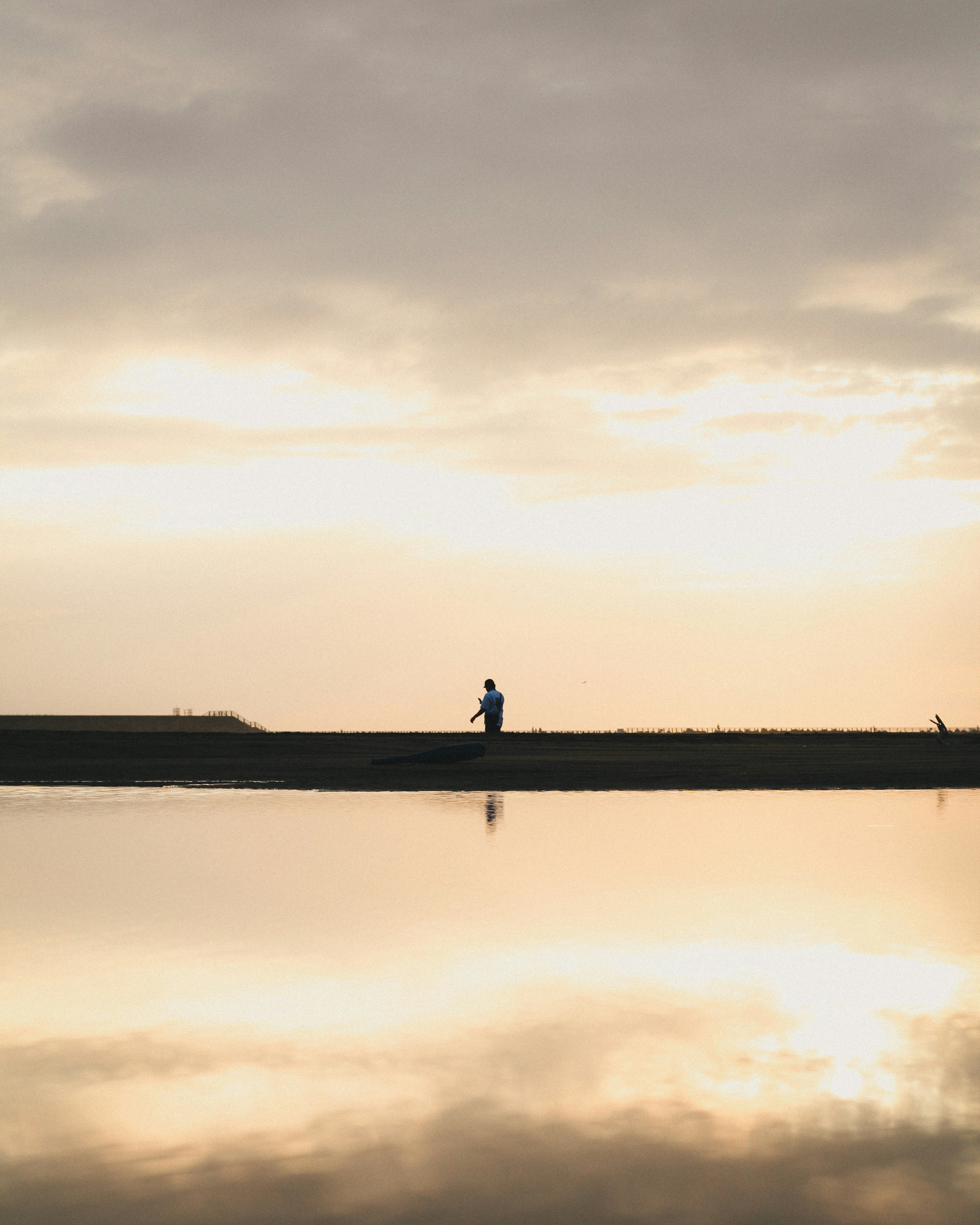 Solitary Figure at the Horizon: A Quiet Sunset Walk