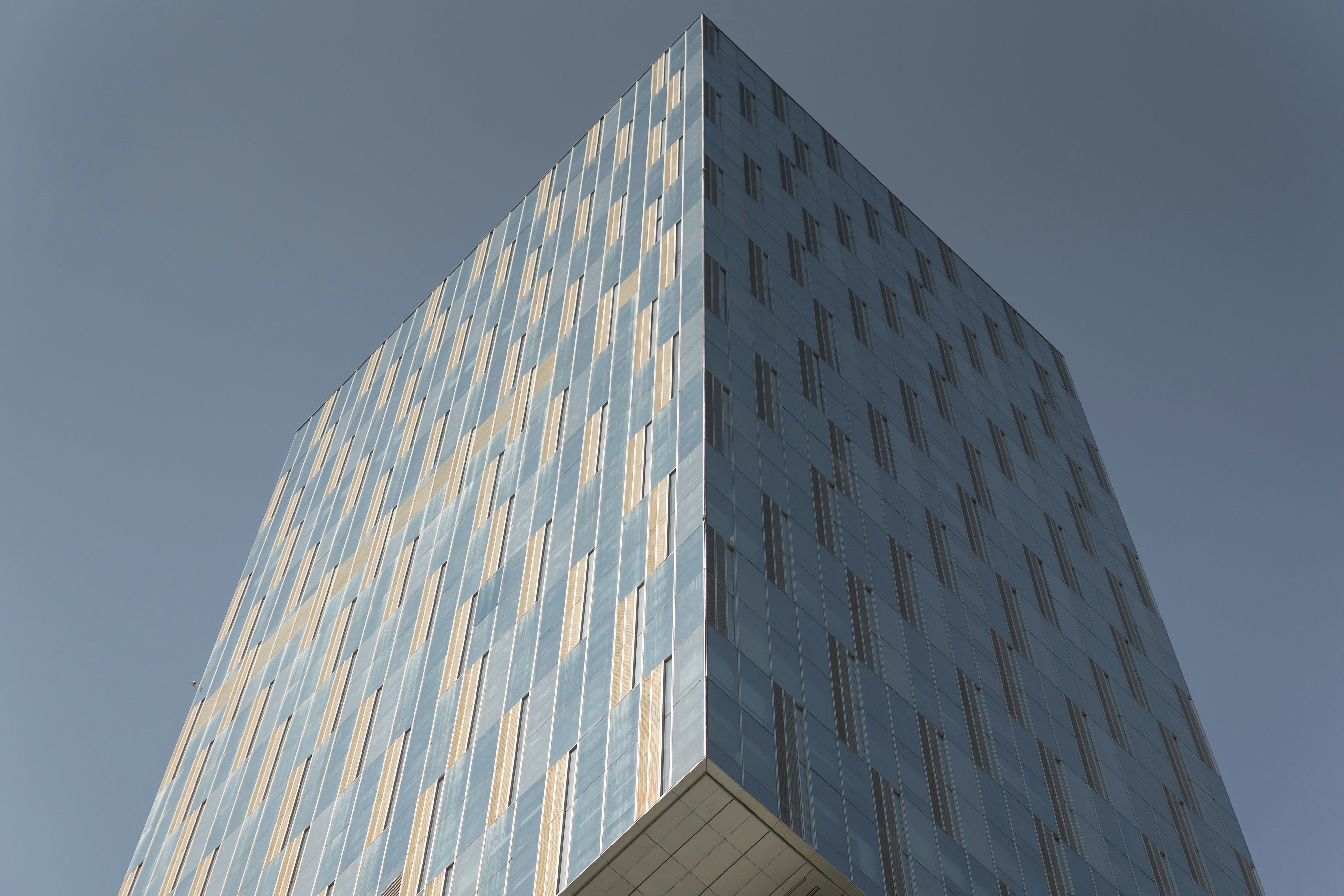 Angular Facade: A Skewed Summit of Glass and Sky