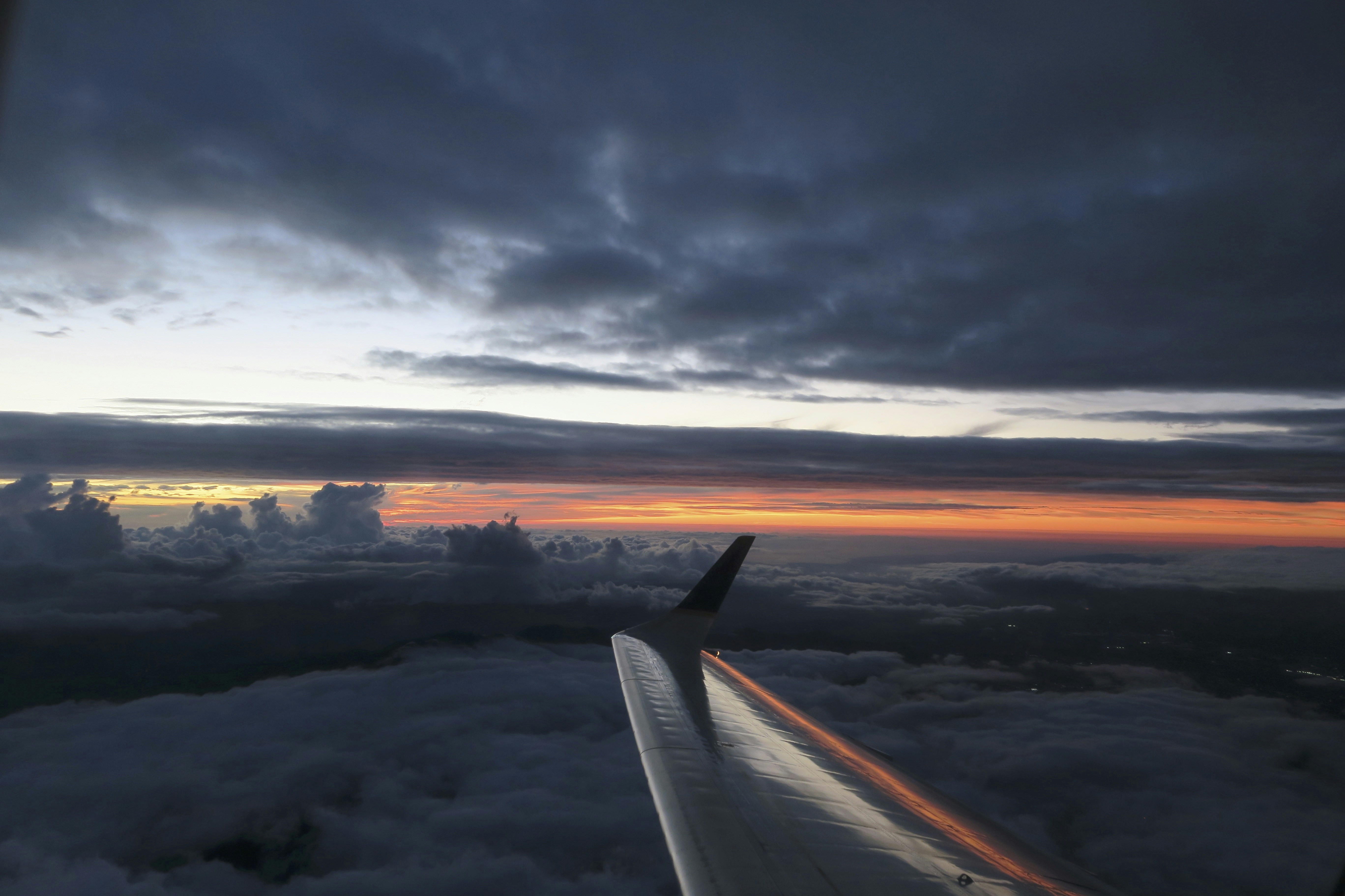 Wingtip in the Golden Hour: Sunset Over Clouds