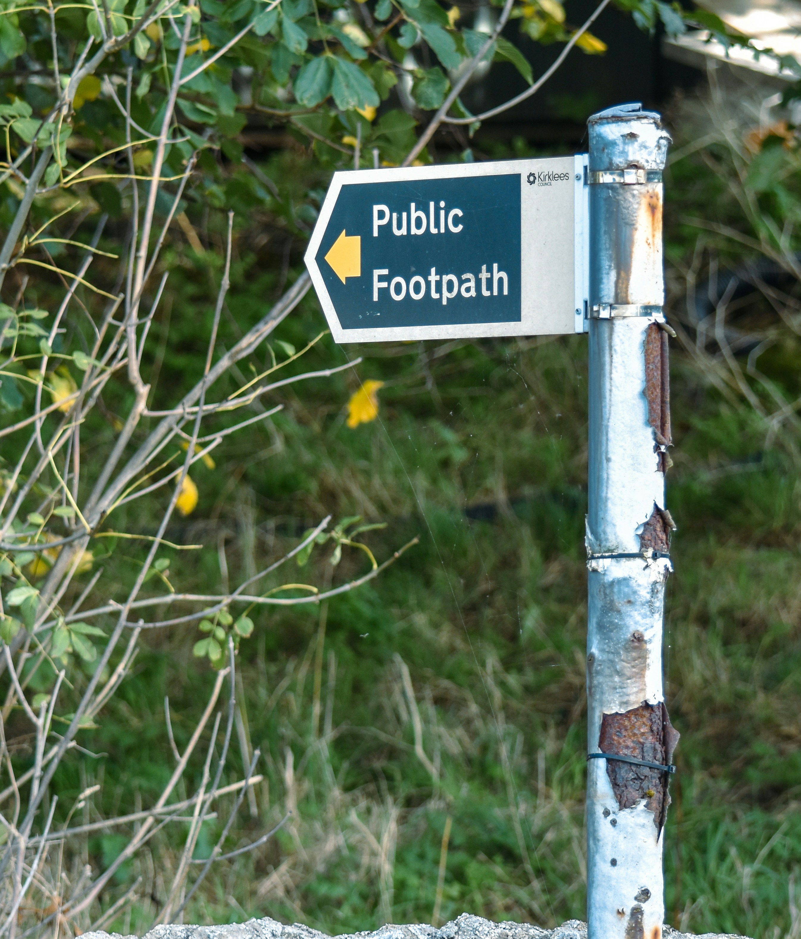 Public Footpath Signpost by Weathered Gate Post