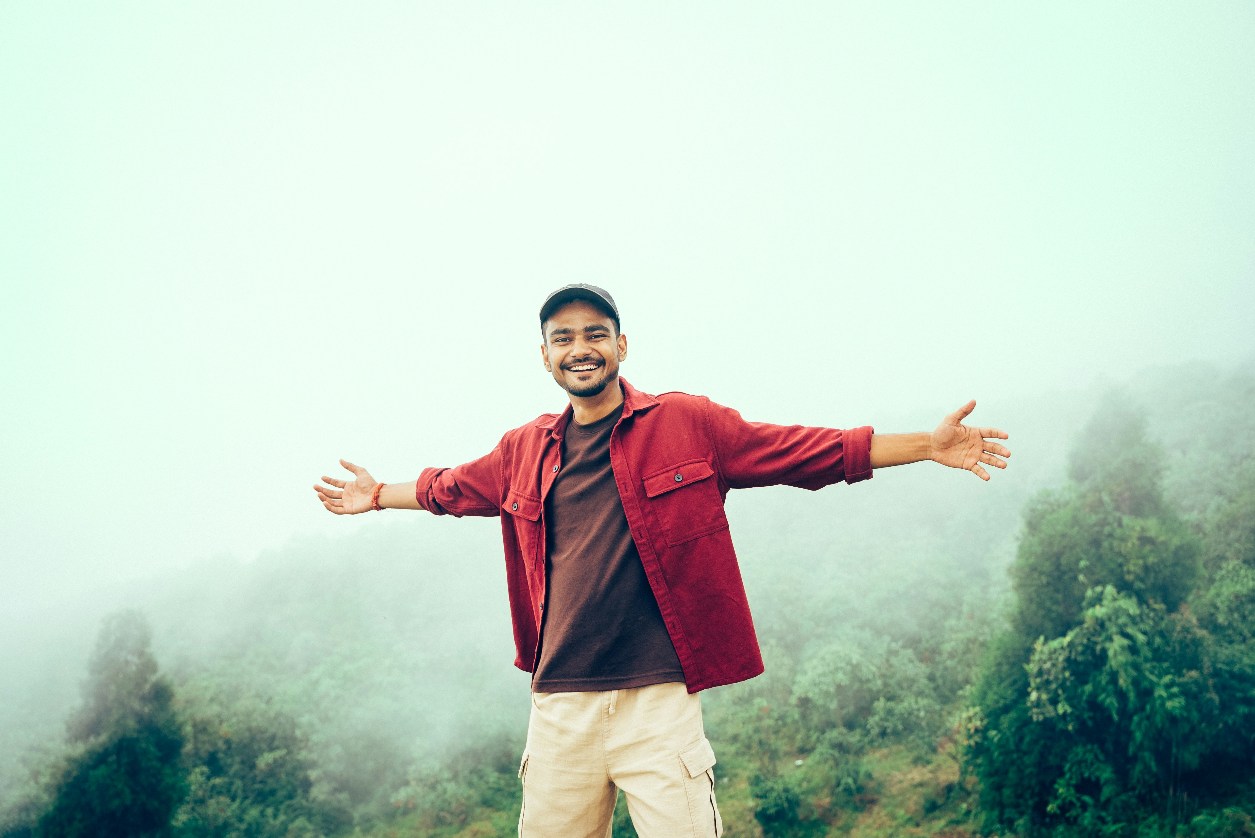 Open-Arm Horizon: A Joyful Welcome from a Misty Ridge