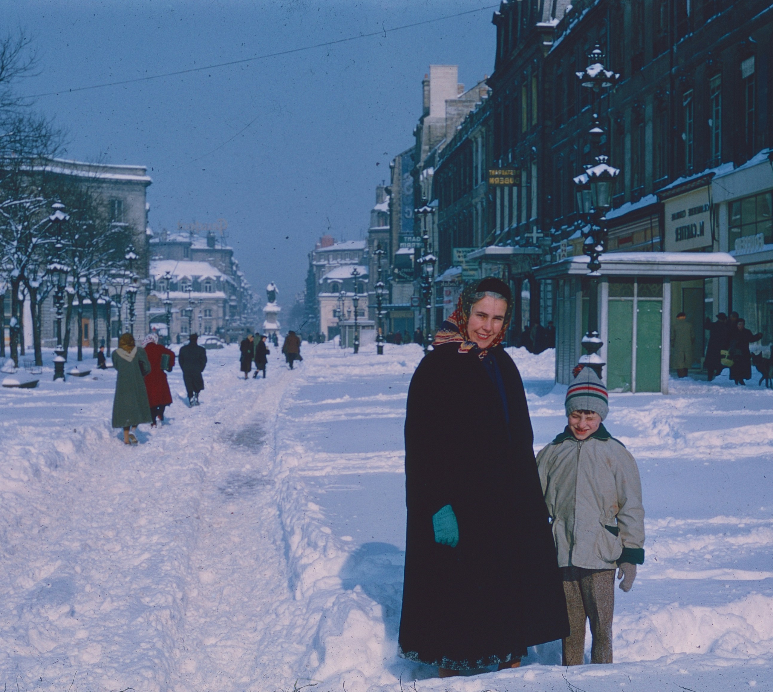 Winter Street Portrait: Mother and Child Amid Snowy Avenues