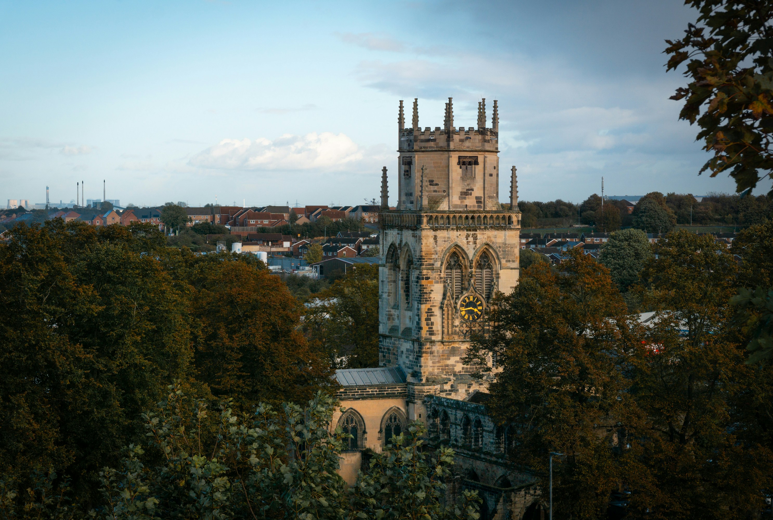 Ancient Bell Tower Rises Above Autumn Canopy