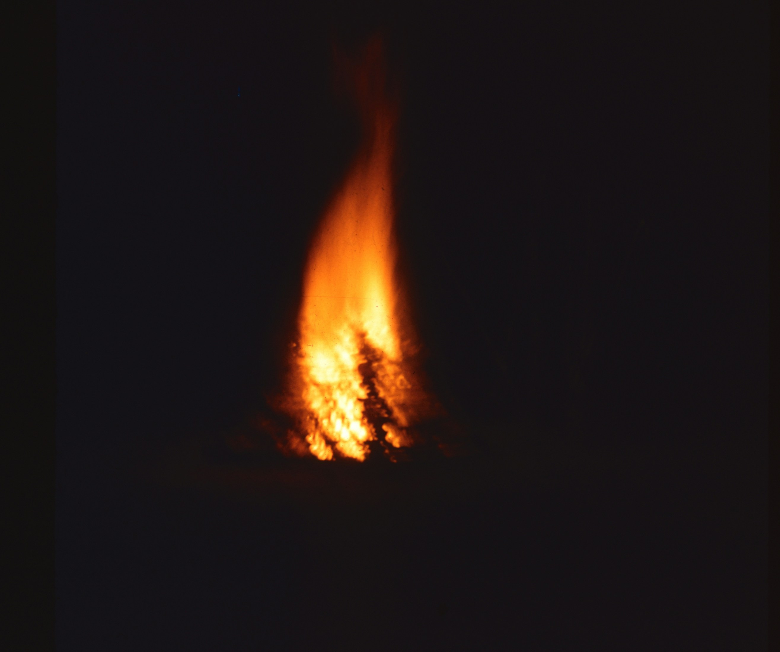 Flames in the Dark: A solitary bonfire leaps from the void