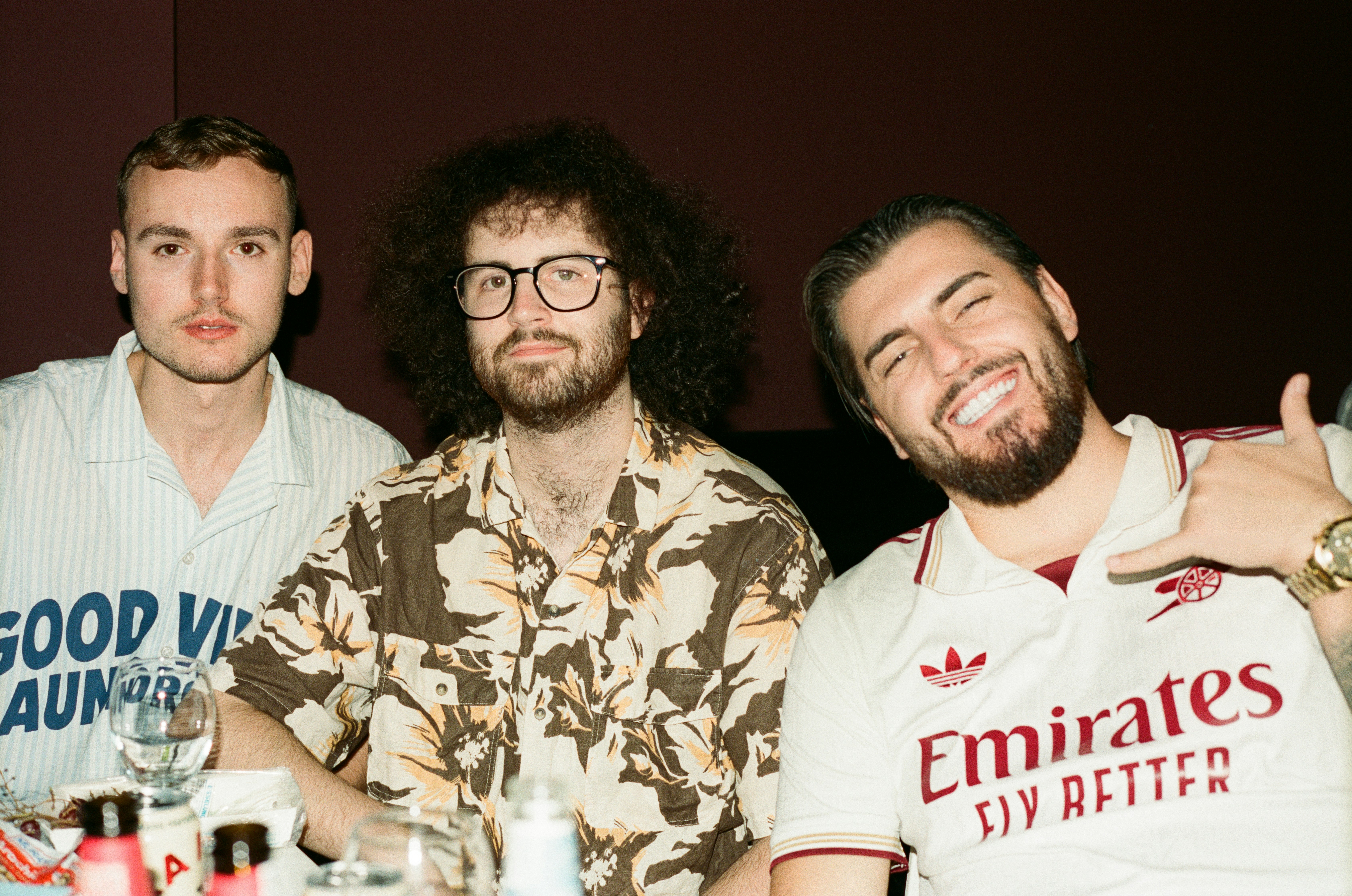 Triad at the Table: A Casual Moment in a Night Out