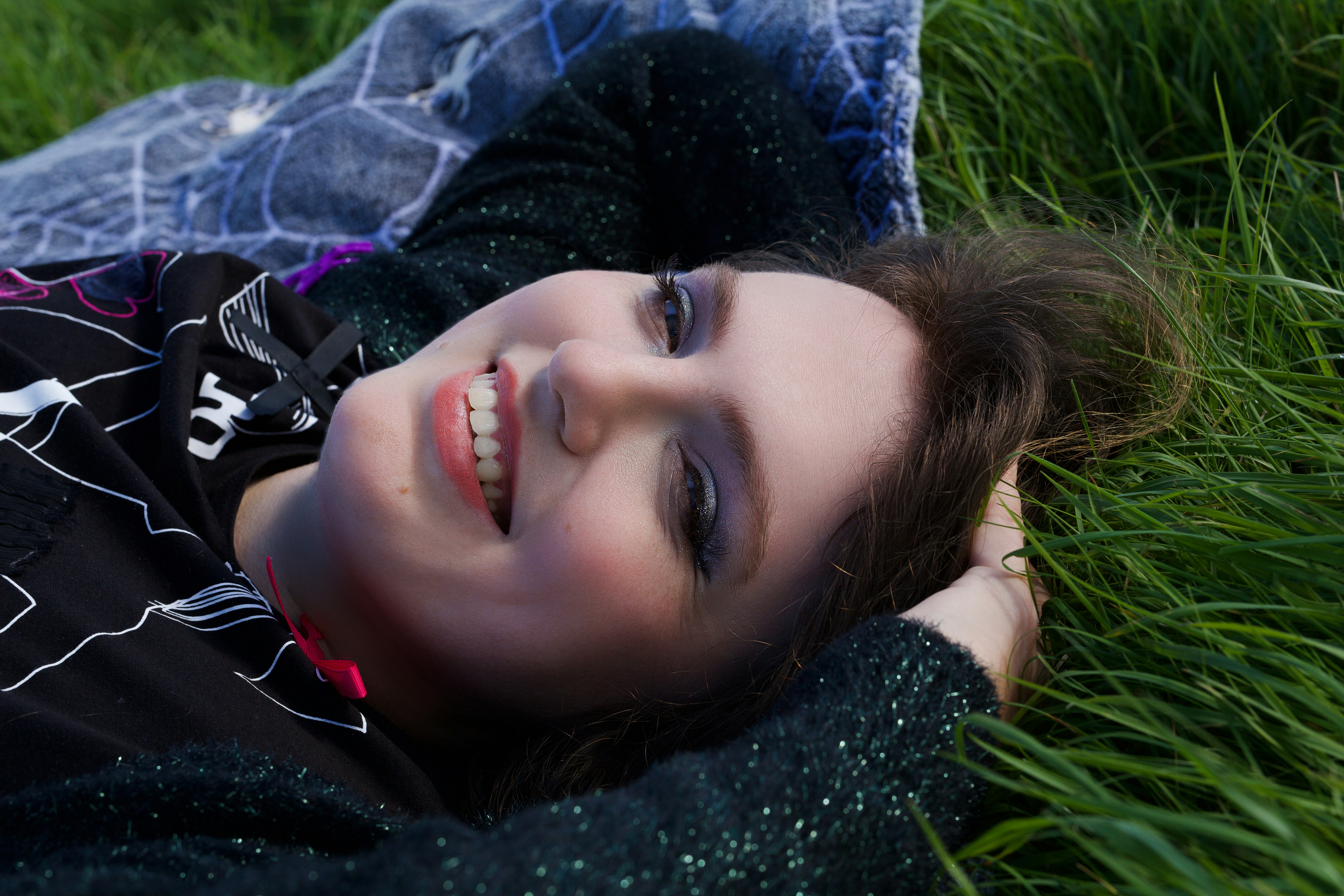 Golden smile beneath a twilight gaze on cool grass