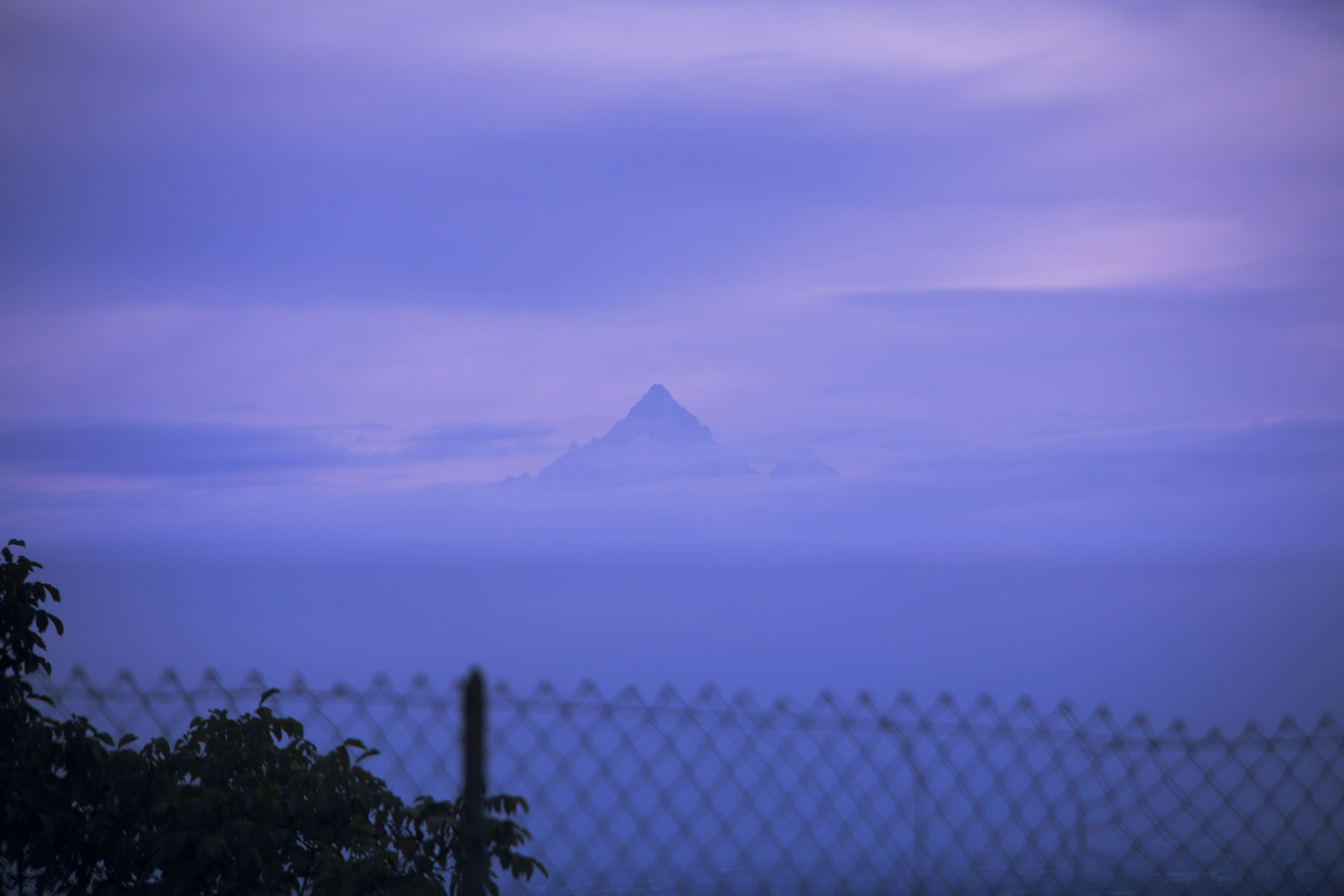 Misty Island Peak Above a Quiet Seascape