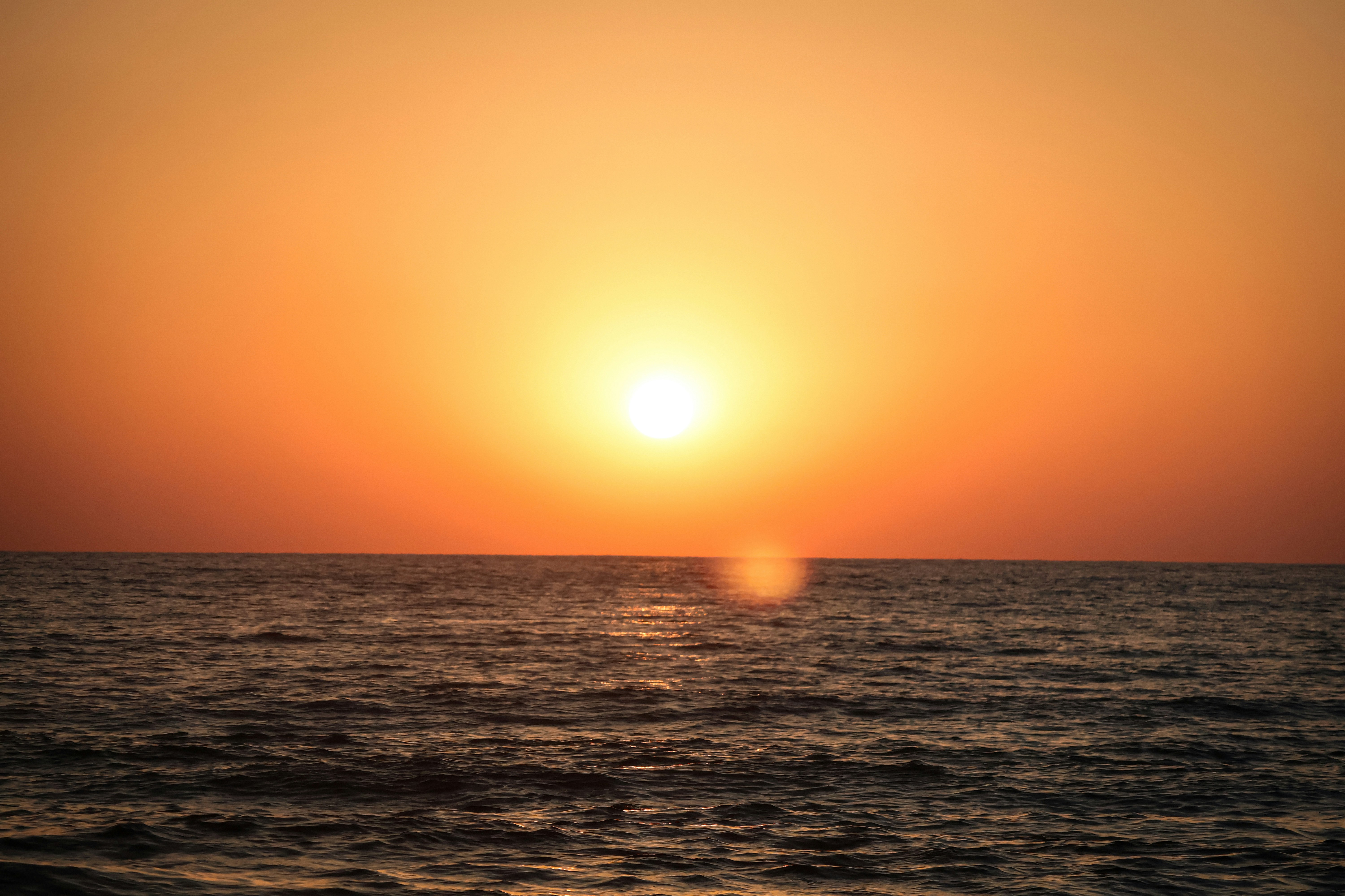 Horizon Fire: A Solitary Sunset Over Calm Seas