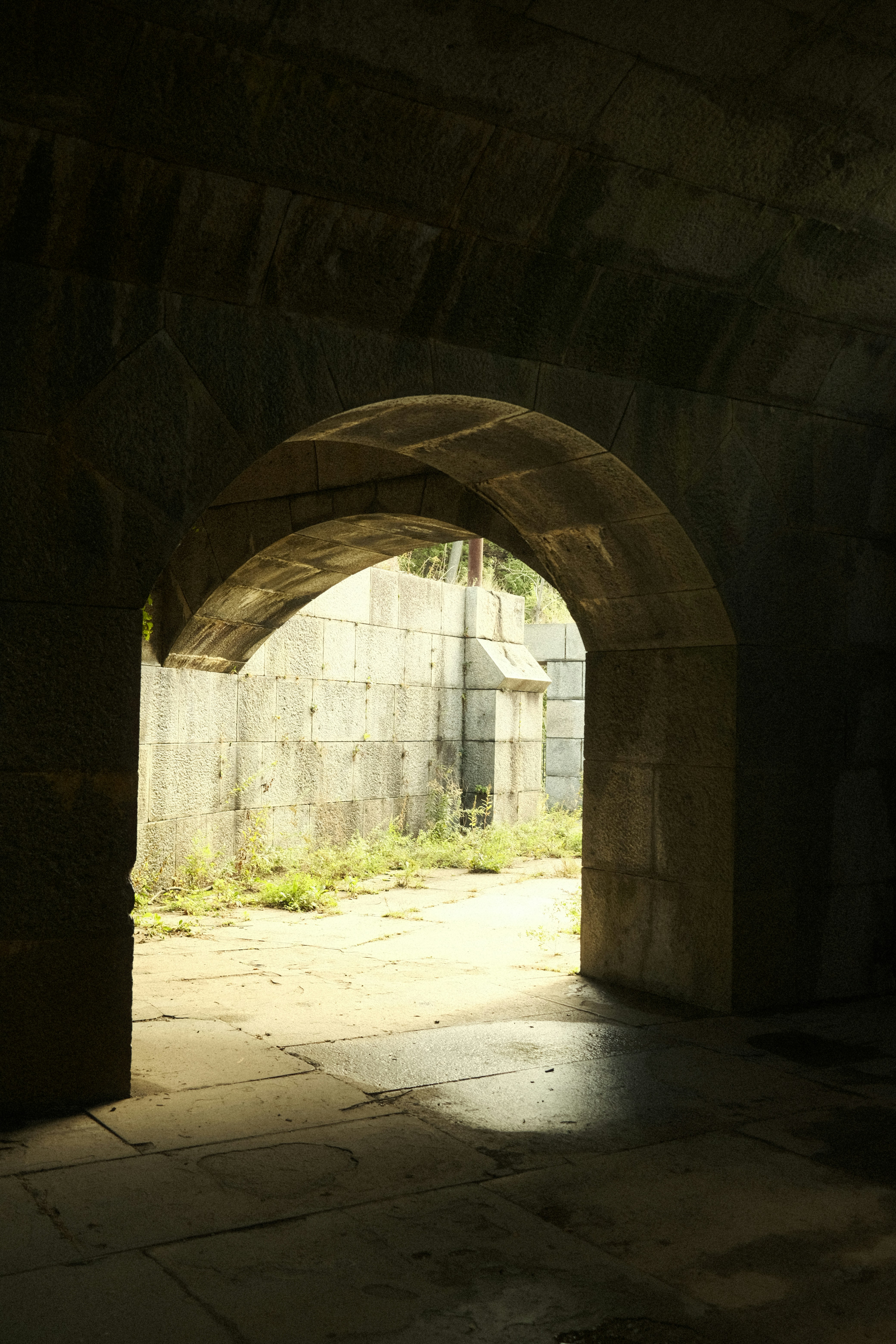Light at the Arch: An Inner Courtyard Through Stone Keystones