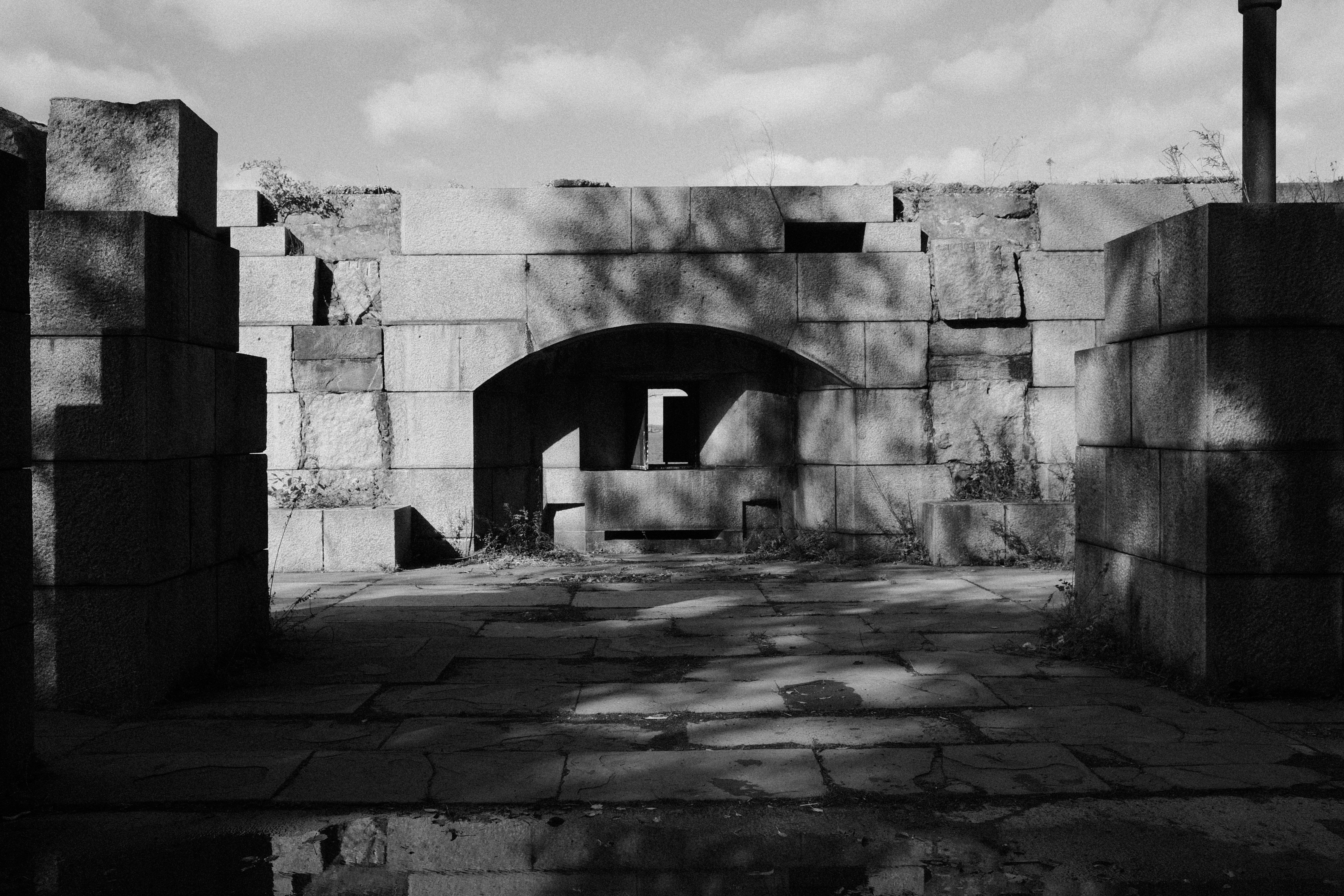 Shadowed Archway Path in Monochrome Courtyard