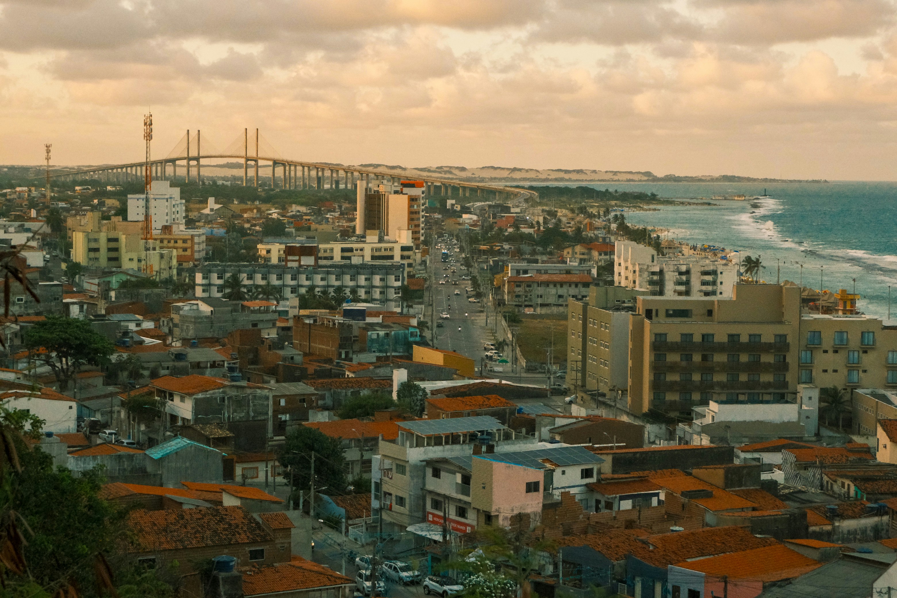 Coastal Cityscape: A Warm Evening Over Red-Tiled Terraces