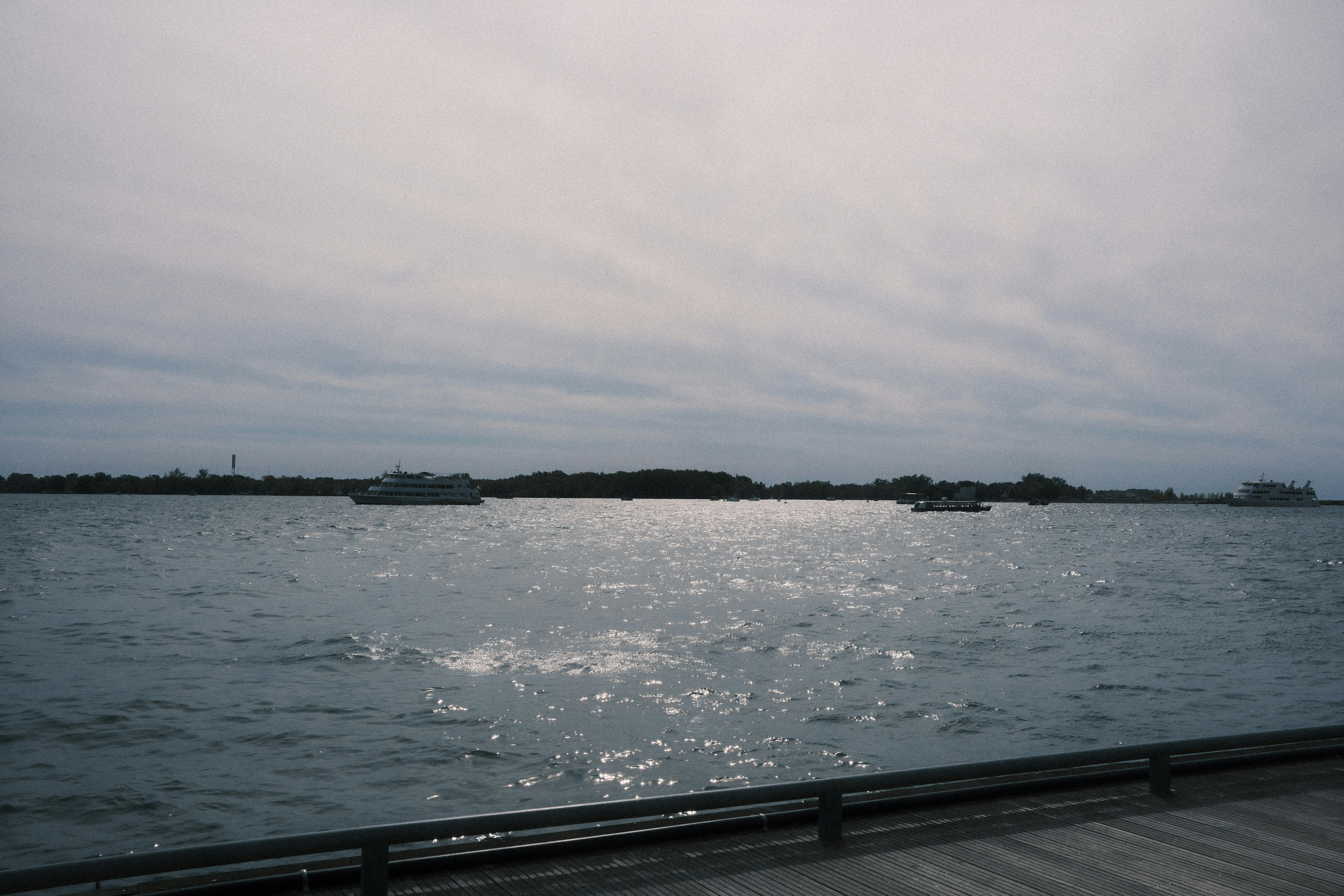Sun- tipped harbor horizon from a quiet seawall