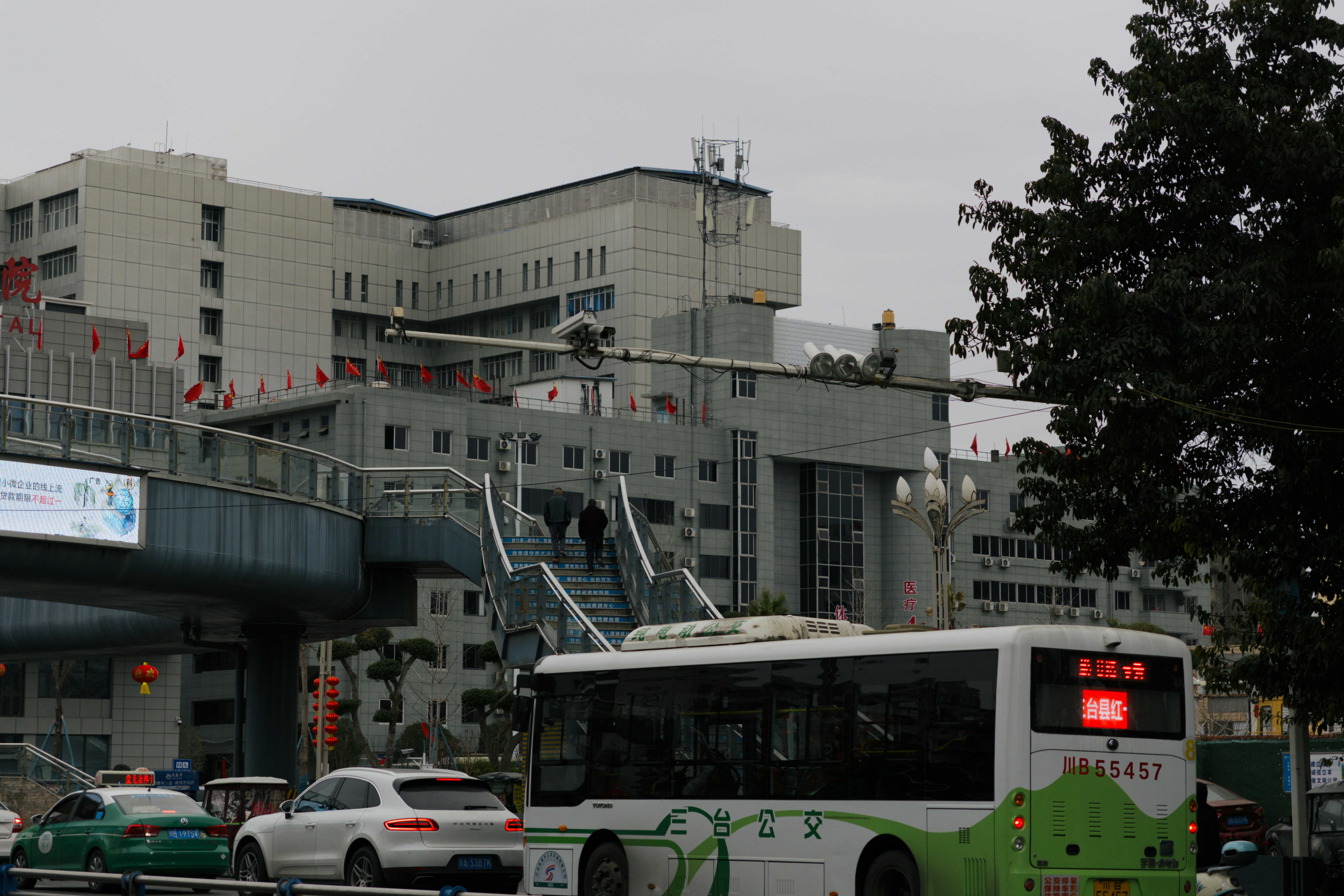 Urban Nexus: Bus in Motion Before a Modern Transit Hub
