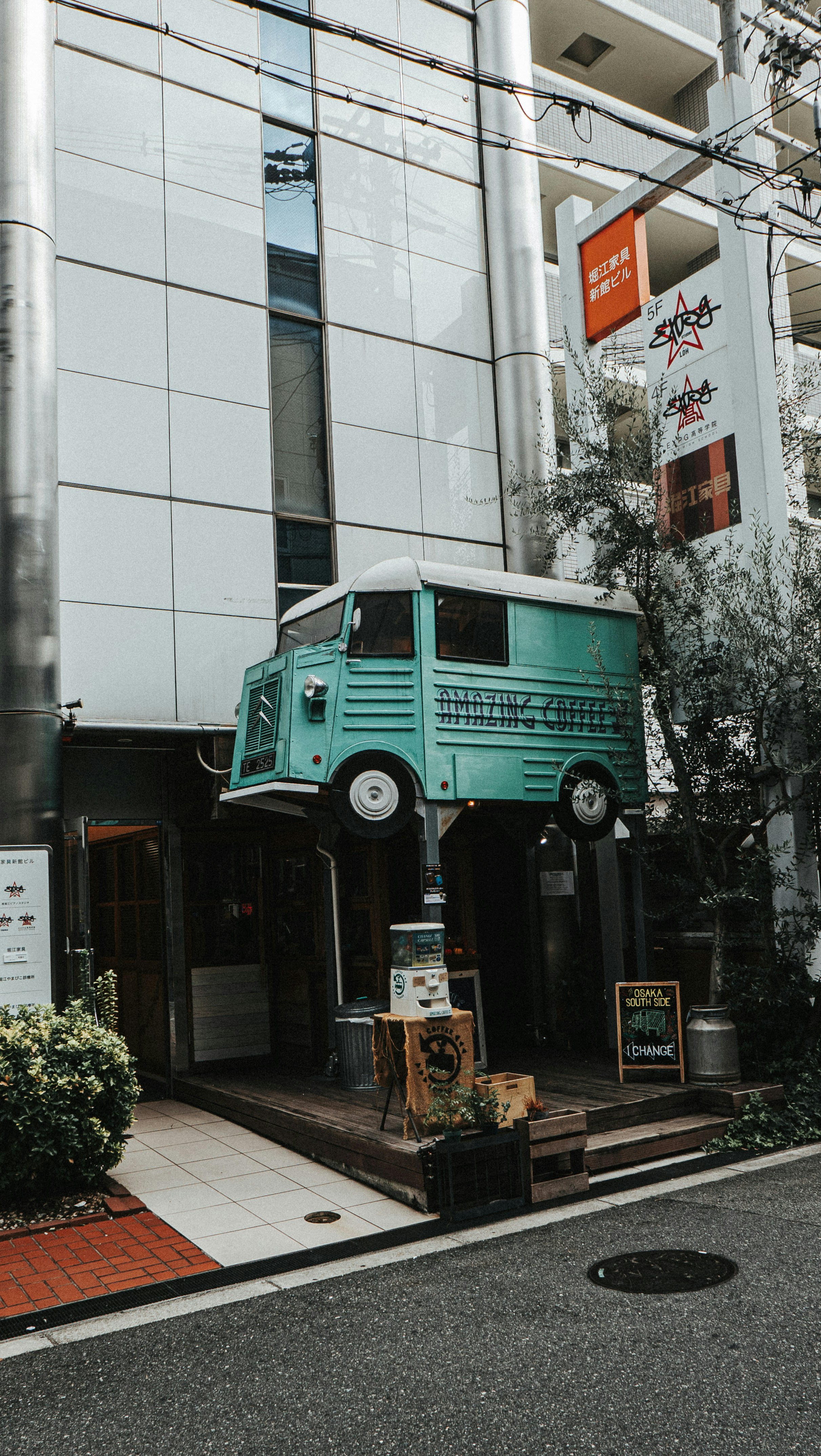 Teal Minivan on a Pedestal: Urban Café Anchorage