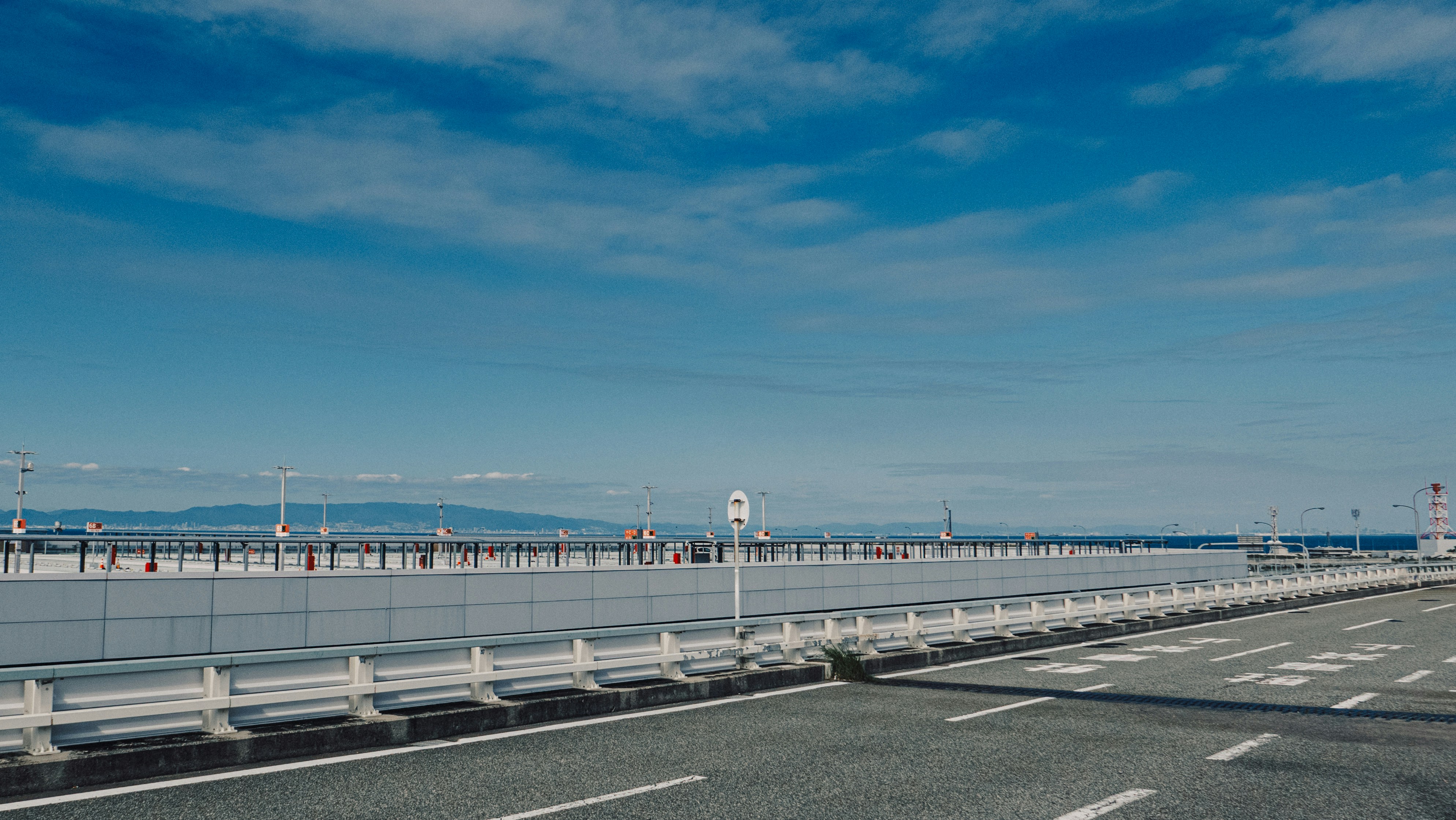 Pier Horizon: Calm Sea Meets Concrete Walkway