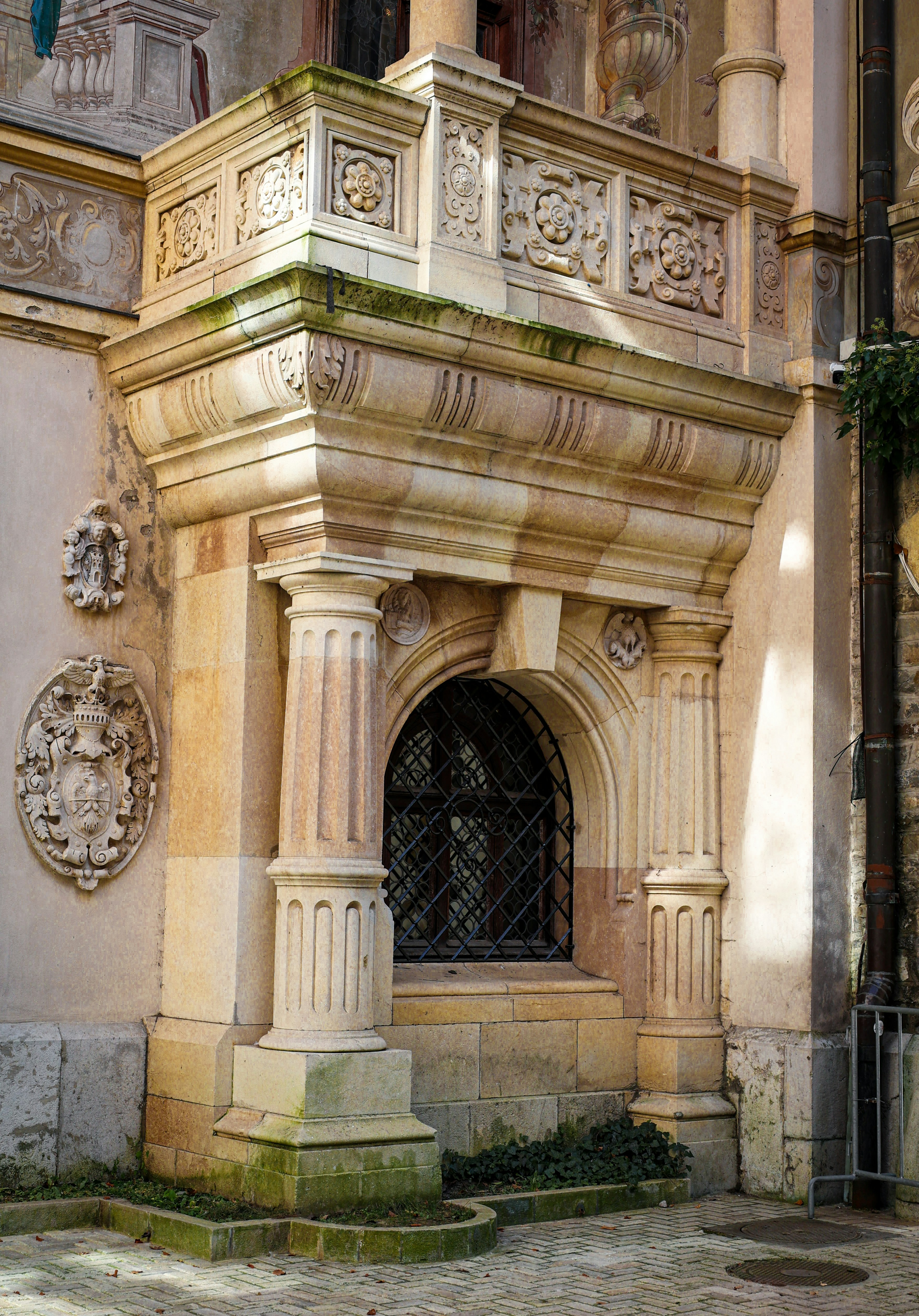Ornate Heritage: Stone Balcony Overlook and Arched Window