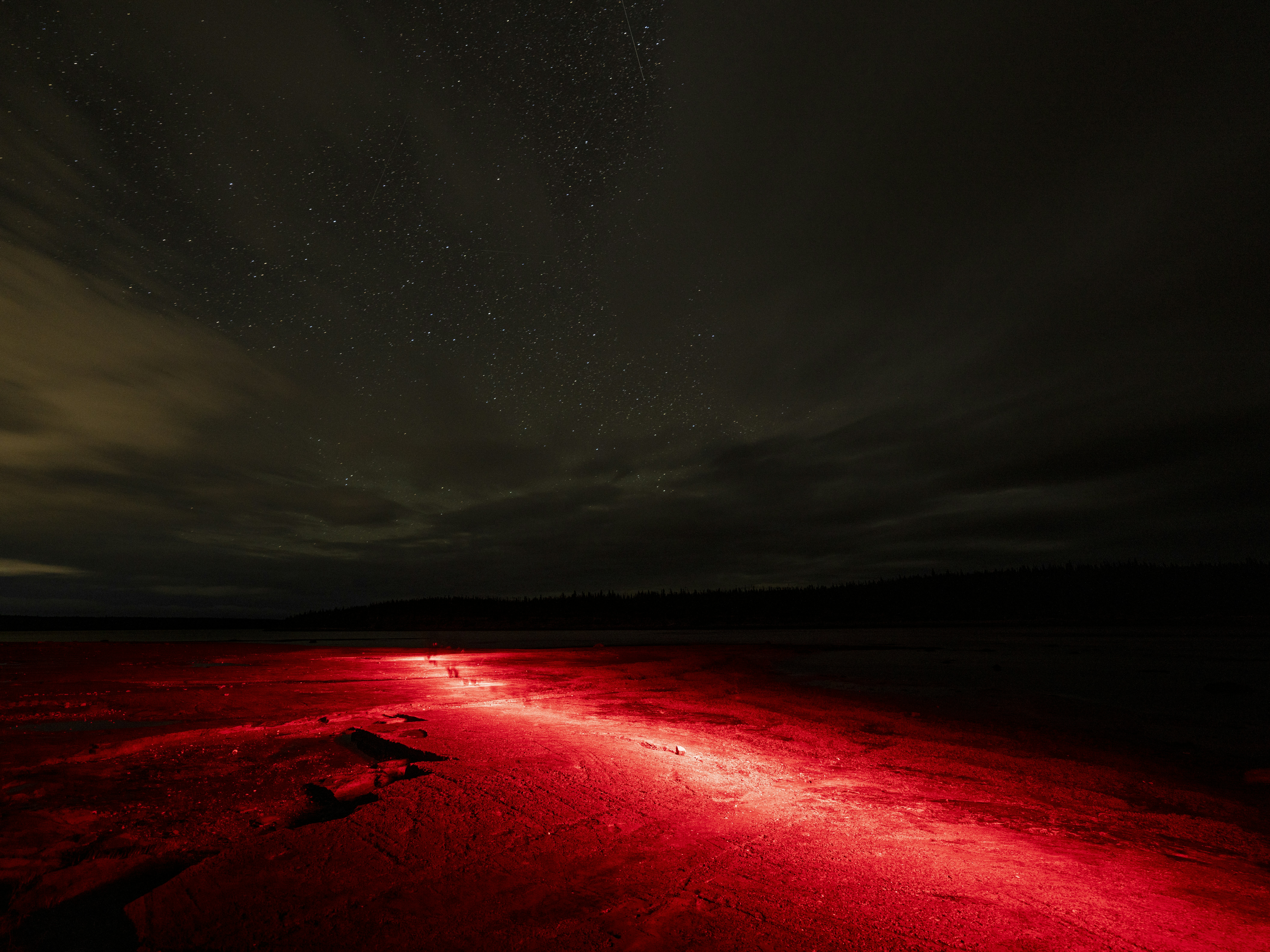 Infrared Red Tide on a Night Shore Under a Starry Sky