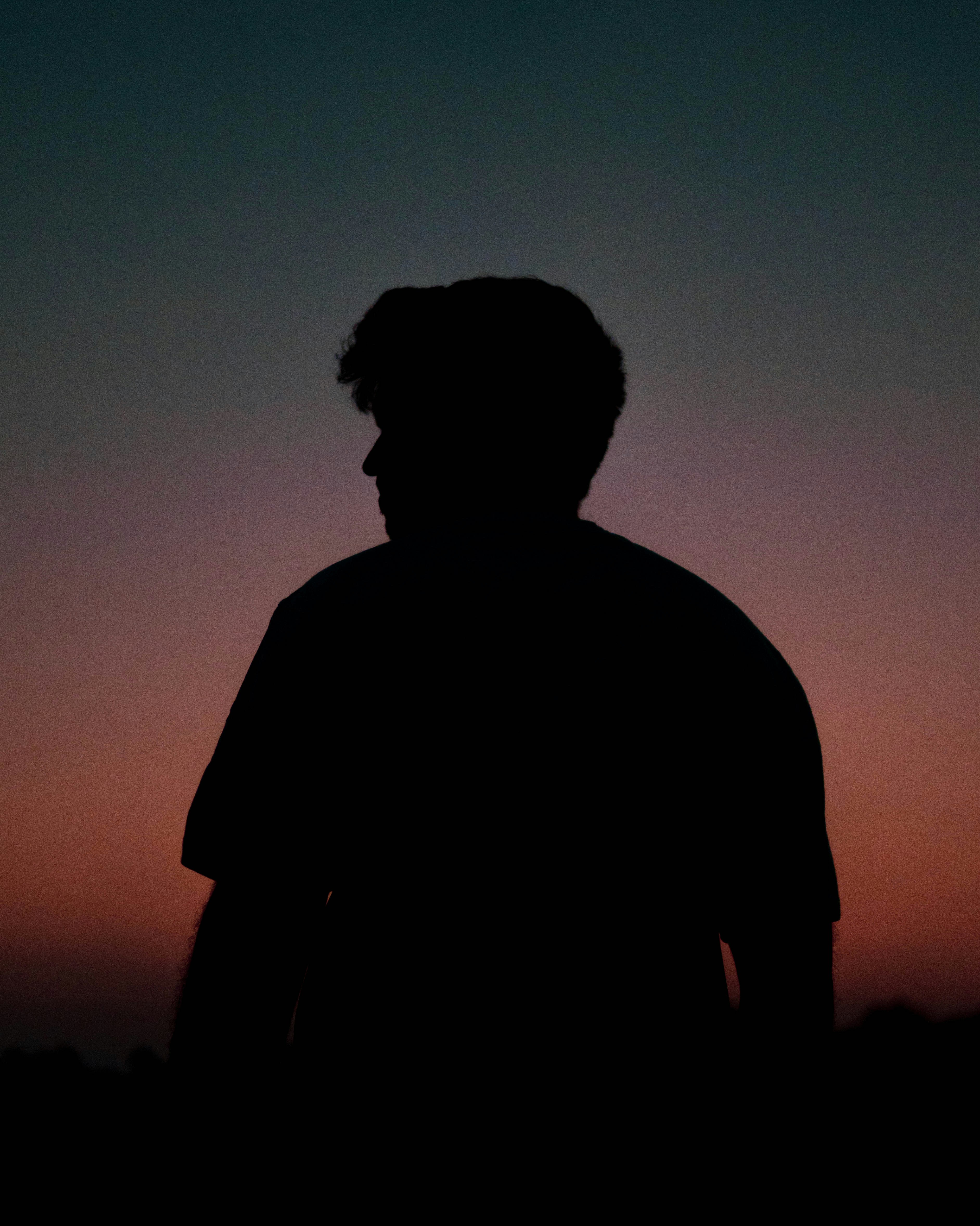 Silhouette at Dusk: A Lone Figure Against a Velvet Sky